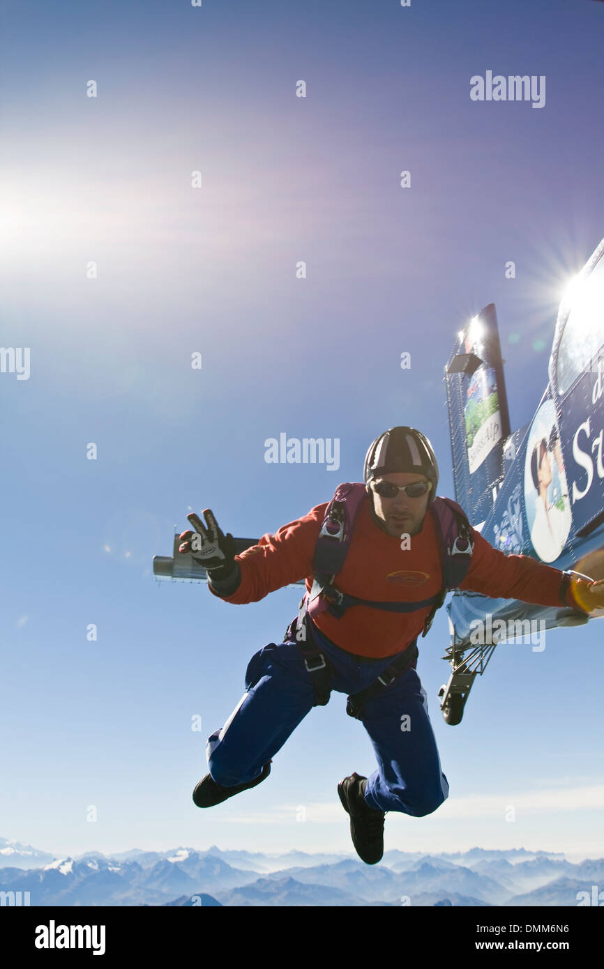 Skydiver is jumping out of a plane. He has fun and is training the ...