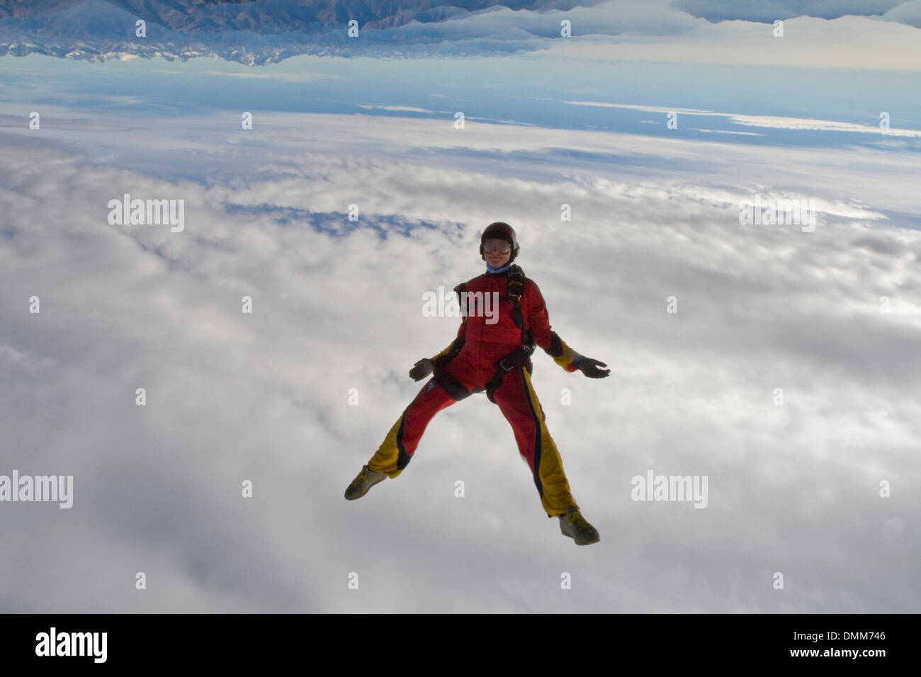 This skydiver woman is falling free in a head down position in the ...