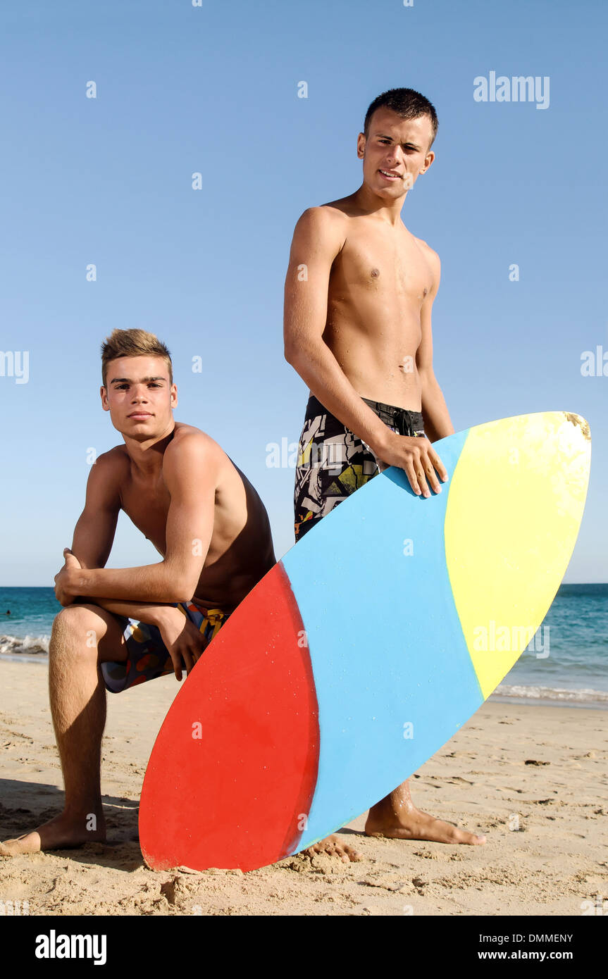 Handsome surfers posing in the beach Stock Photo - Alamy