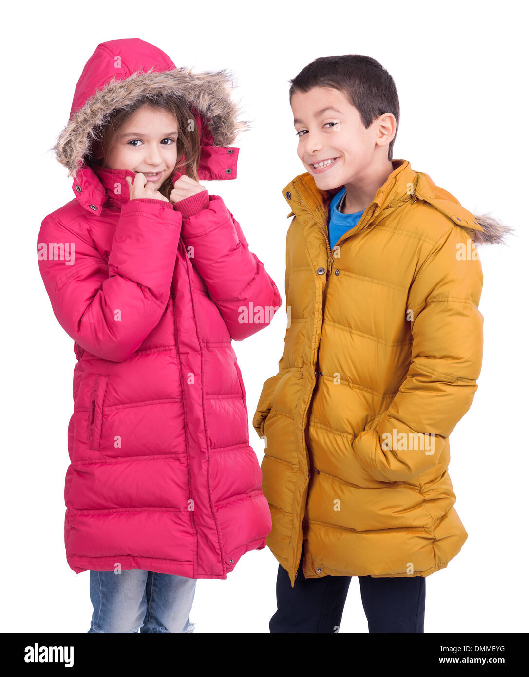 Children couple posing in colorful winter coats isolated in white Stock ...
