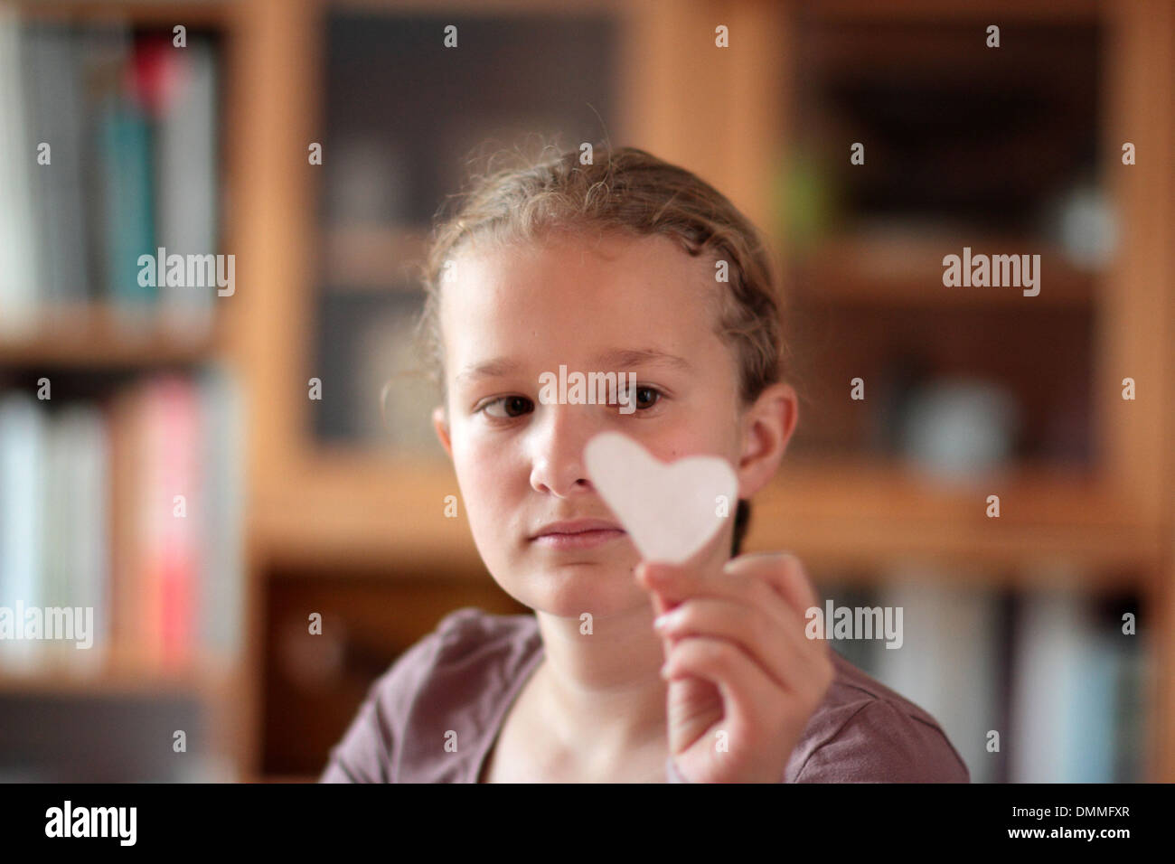 Girl looking to a heart Stock Photo - Alamy