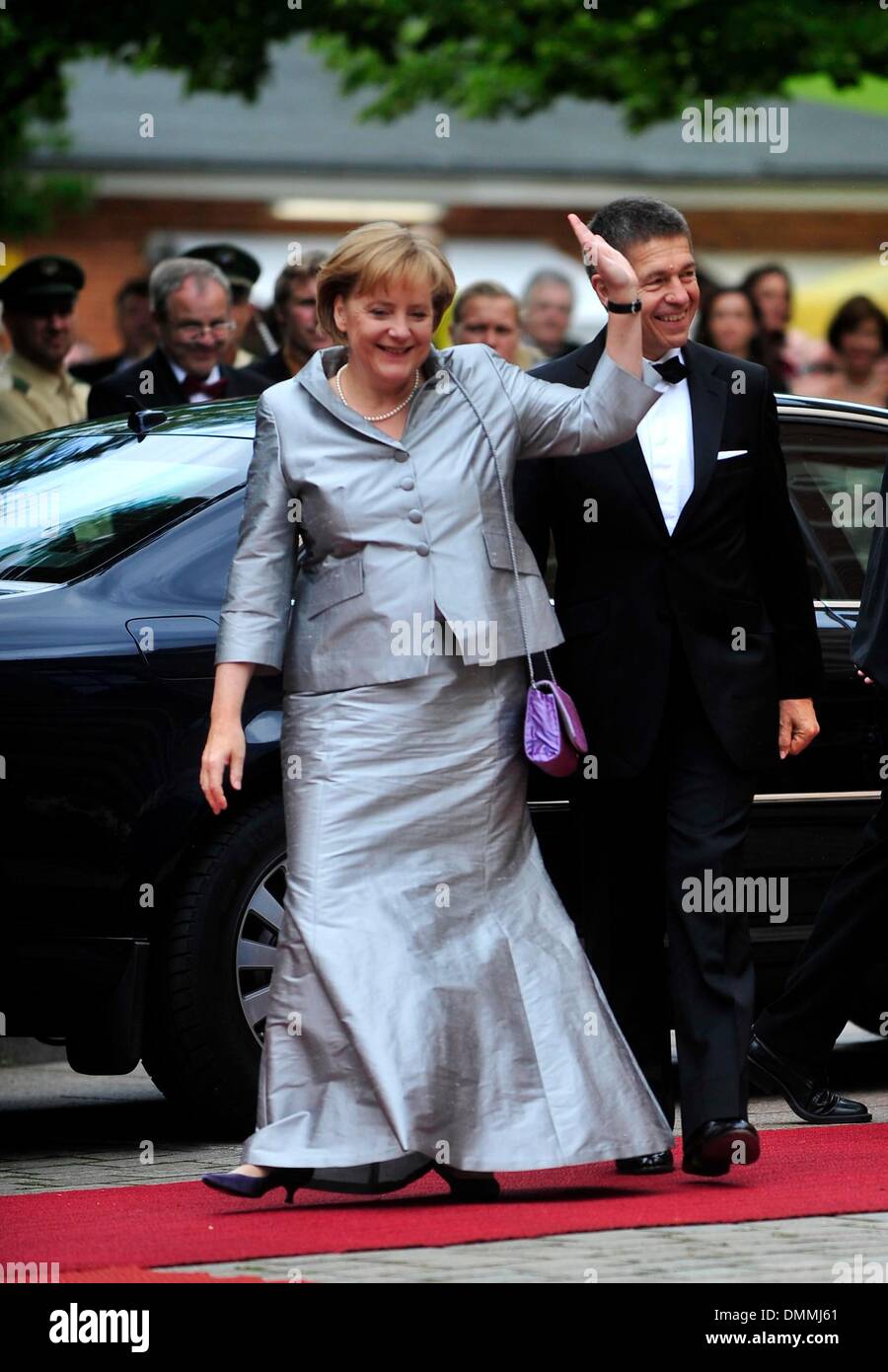 Angela Merkel and her husband Joachim Sauer arrive at the opening event ...