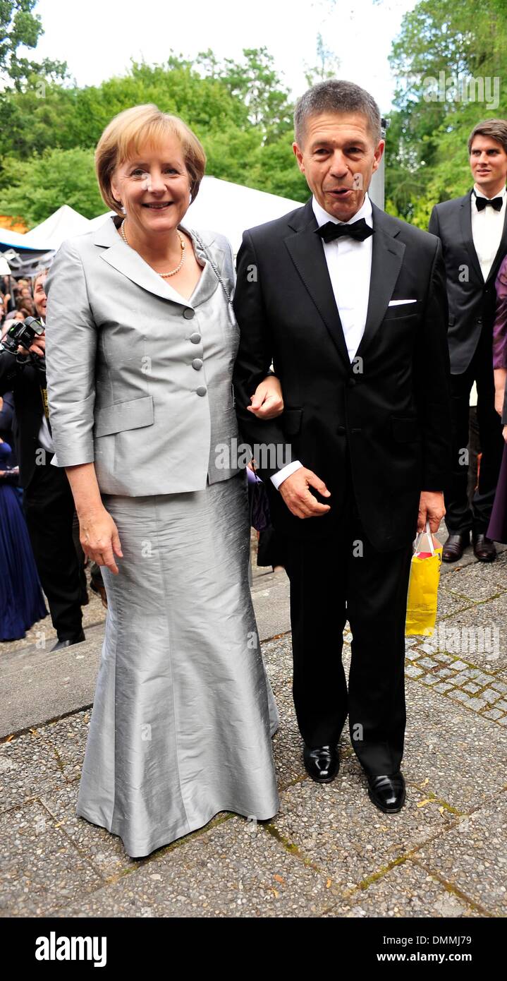 Angela Merkel and her husband Joachim Sauer arrive at the opening event ...
