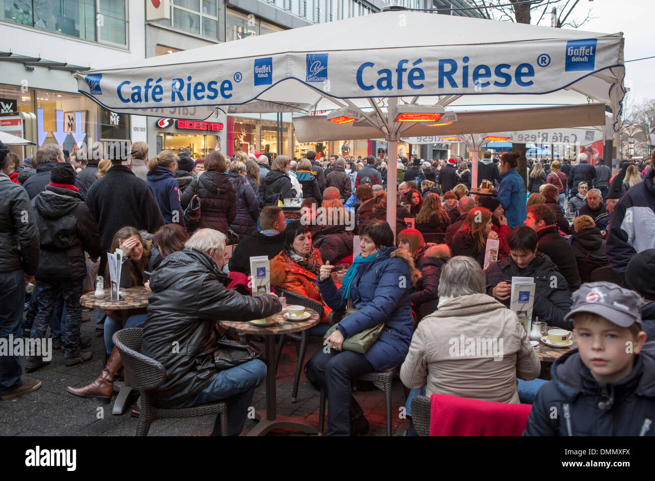 Cologne: people drinking coffee at the main shopping street at the ...