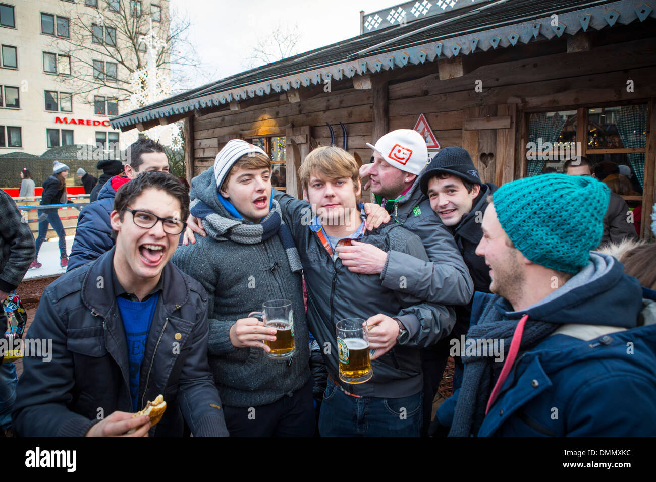 Group of Belgian visitors having fun and drinking beer at the Christmas ...