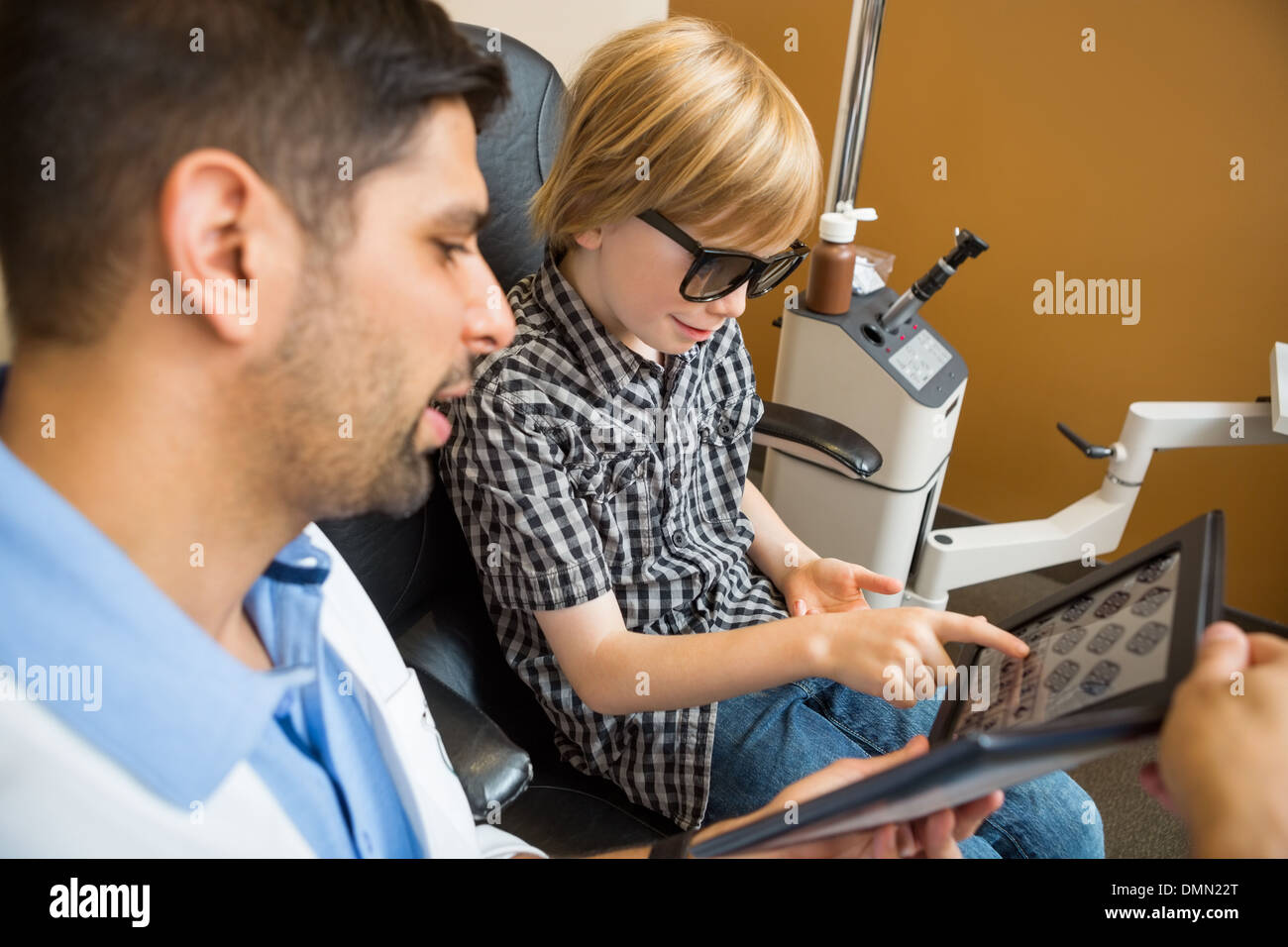 Boy Reading Test Chart While Optometrist Stock Photo - Alamy