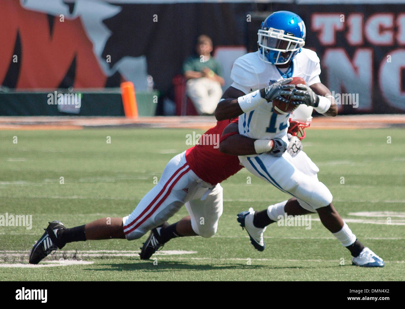 UK's Eric Adeyemi, right, was brought down by Miami's Jeff Thompson in ...