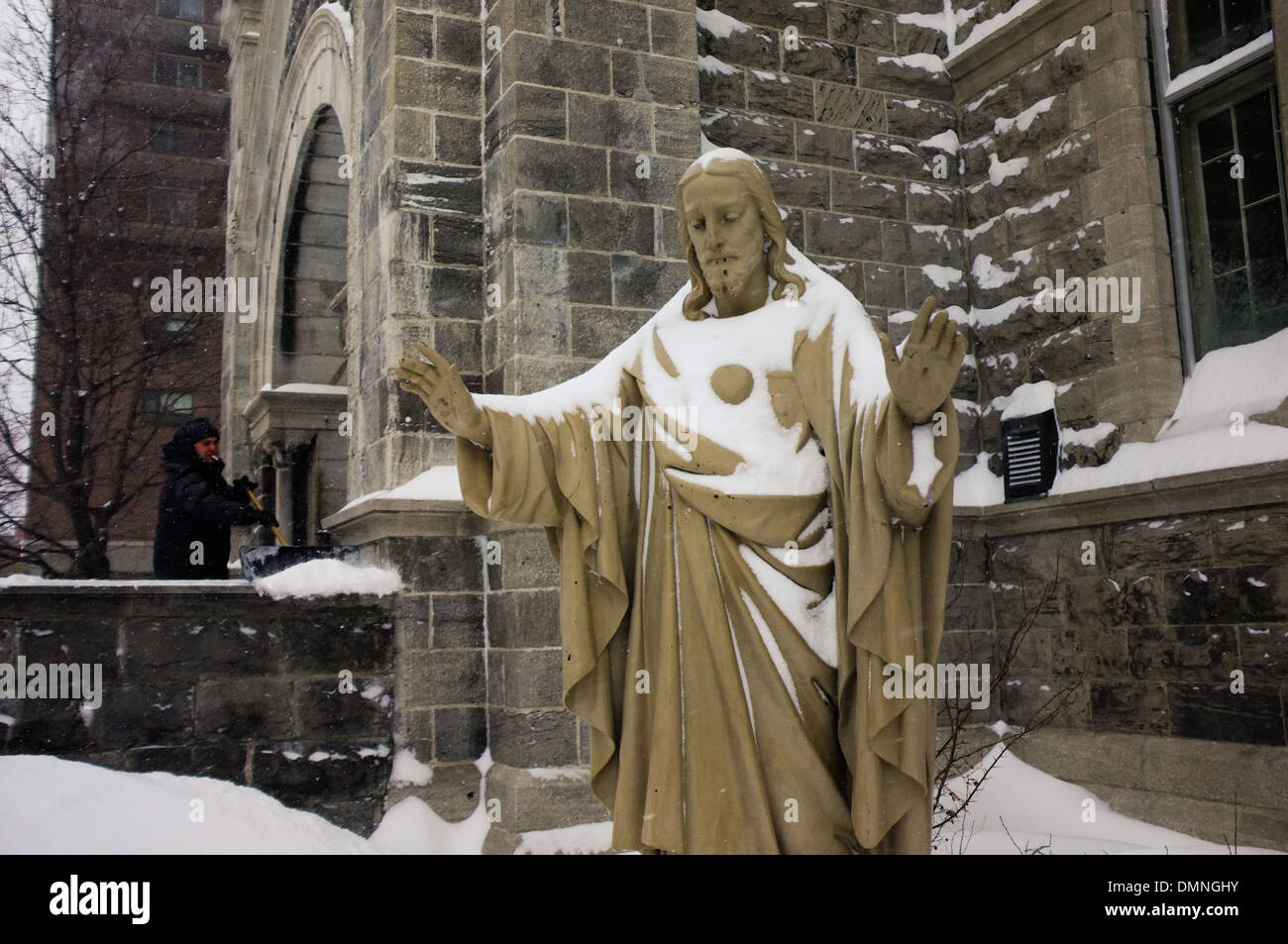 A statue of Jesus Christ covered in snow in the Plateau of Montreal, Quebec Stock Photo - Alamy