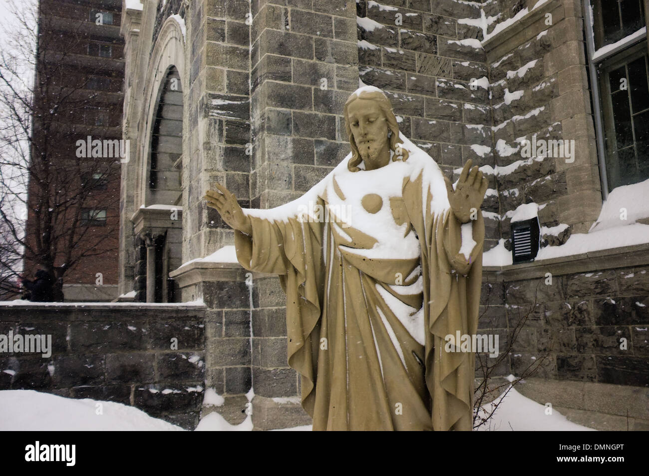 A statue of Jesus Christ covered in snow in the Plateau of Montreal ...