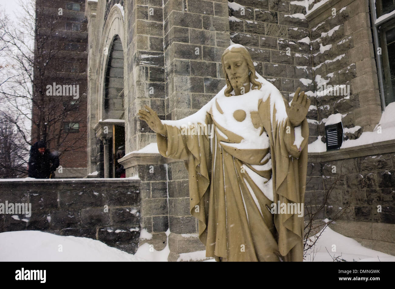 A statue of Jesus Christ covered in snow in the Plateau of Montreal ...