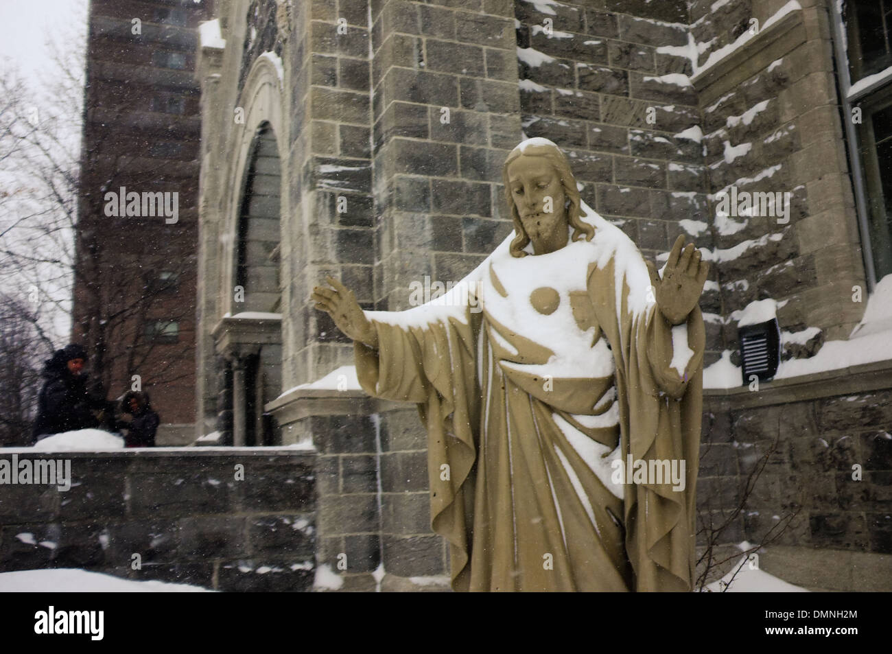 A statue of Jesus Christ covered in snow in the Plateau of Montreal, Quebec Stock Photo - Alamy