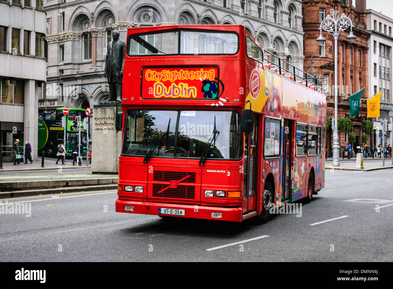 Red Sightseeing Dublin Bus escorting a group of tourists around the ...