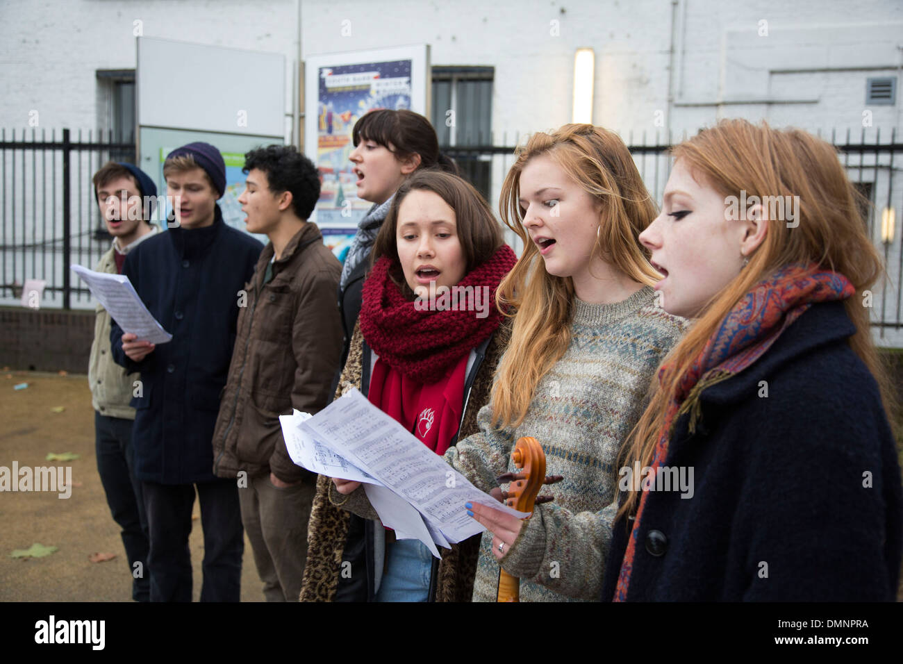 Young student Christmas carol singers performing / busking on the South ...