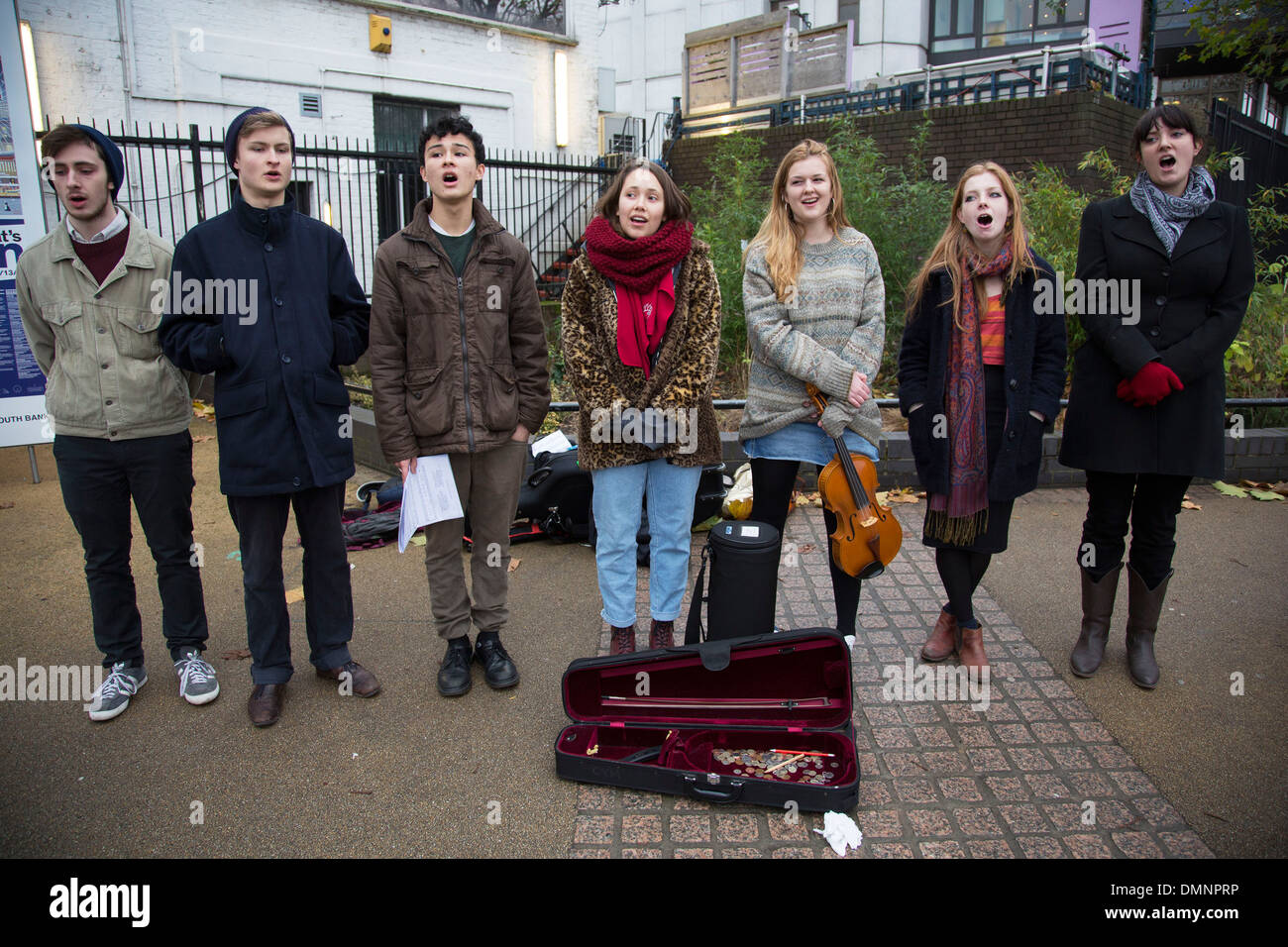 Young student Christmas carol singers performing / busking on the South ...