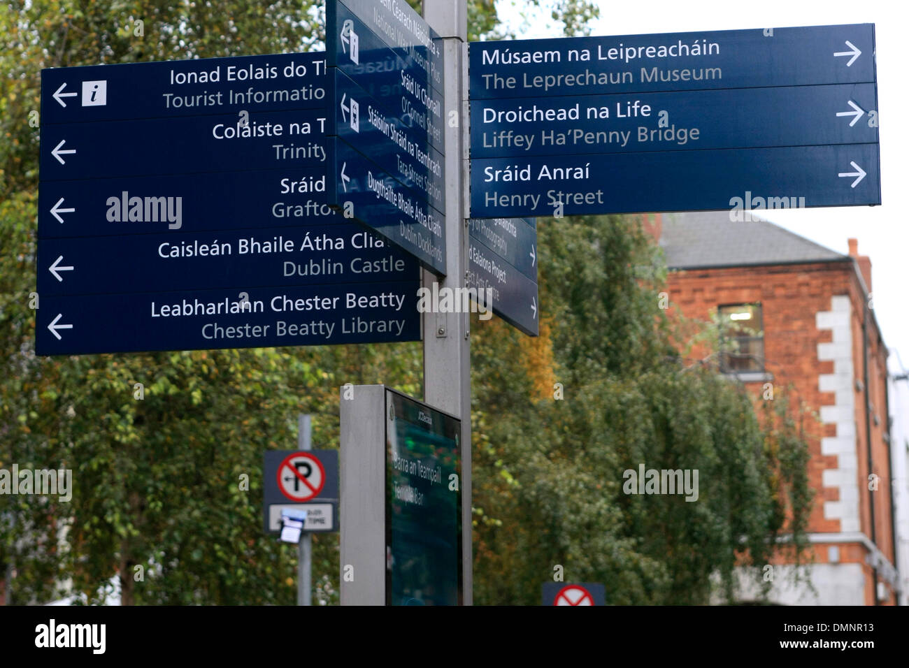 Pedestrian signpost in Dublin showing both English and Gaelic names ...