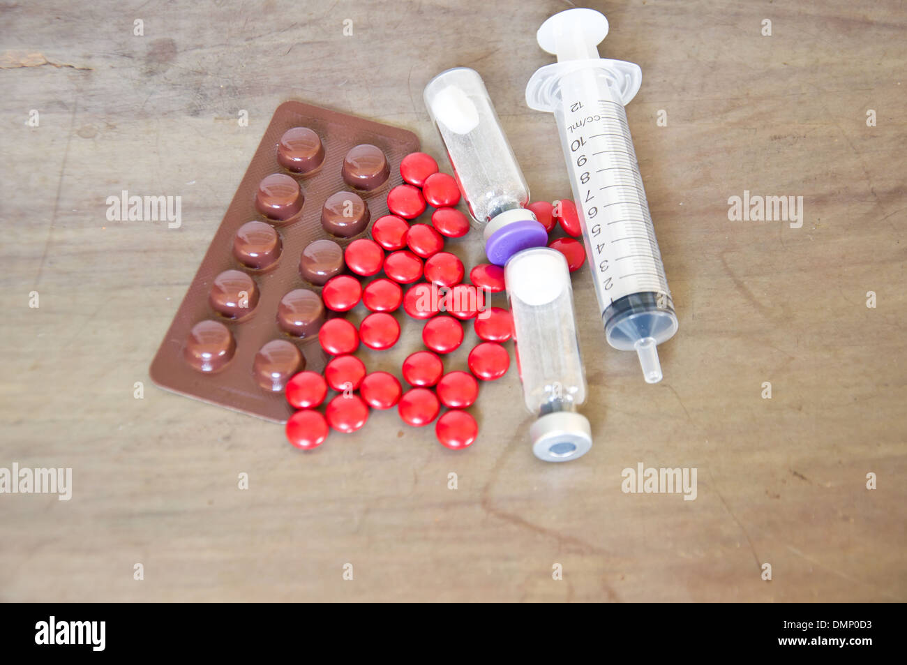 red drug with syringe on wood Stock Photo - Alamy