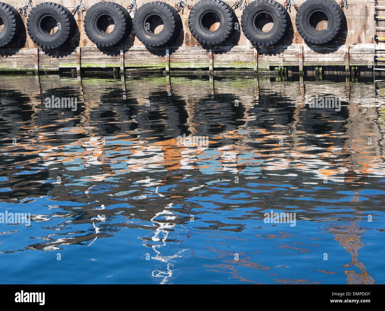 Pier in the Oslo Norway Harbour, tyres as buffer, reflections in the ...