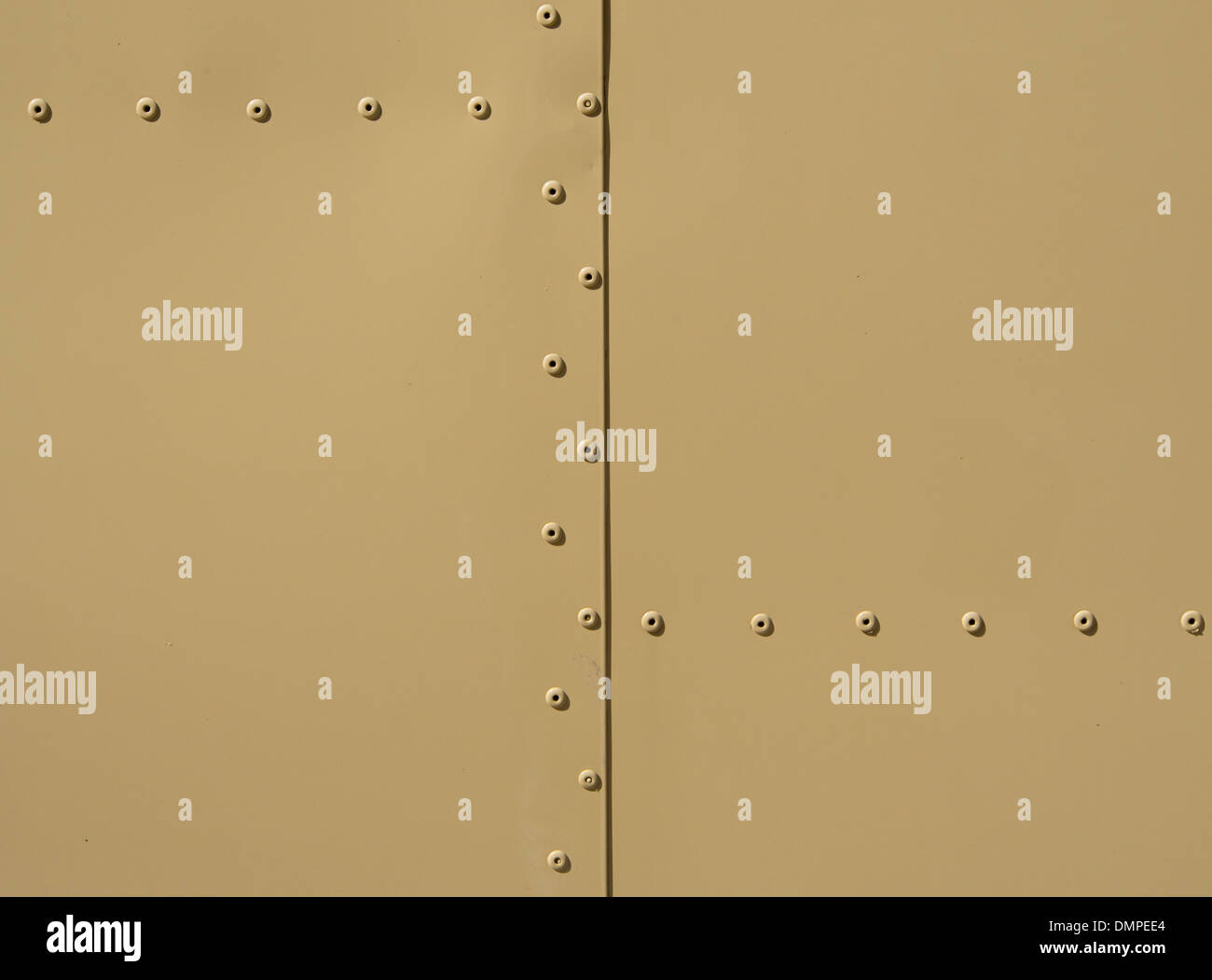 background image, steel plates of old bus painted pale yellow, joints ...