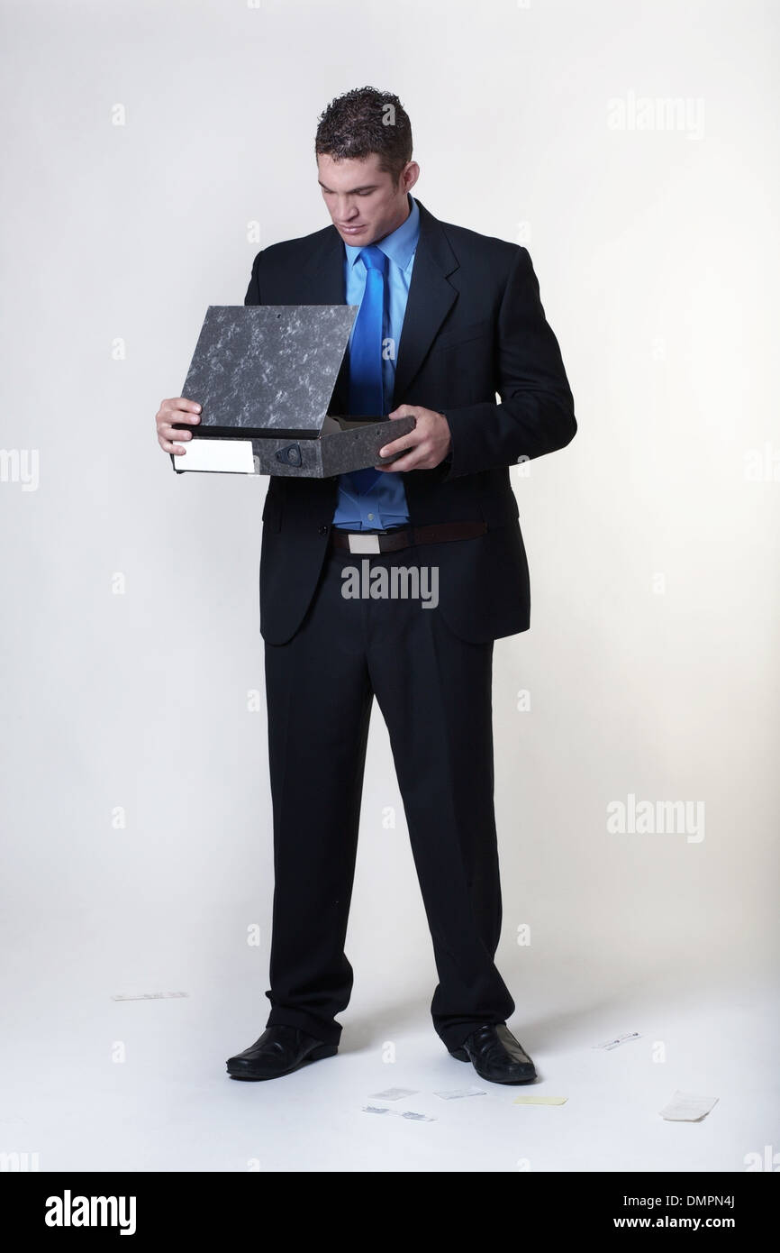 business man looking at receipts from a box file Stock Photo - Alamy