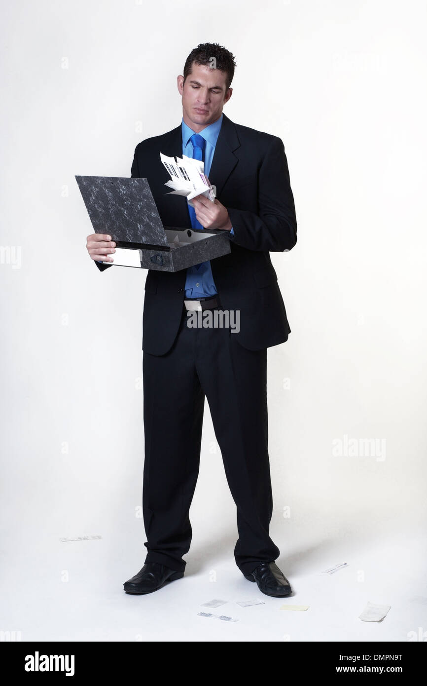 business man looking at receipts from a box file Stock Photo - Alamy
