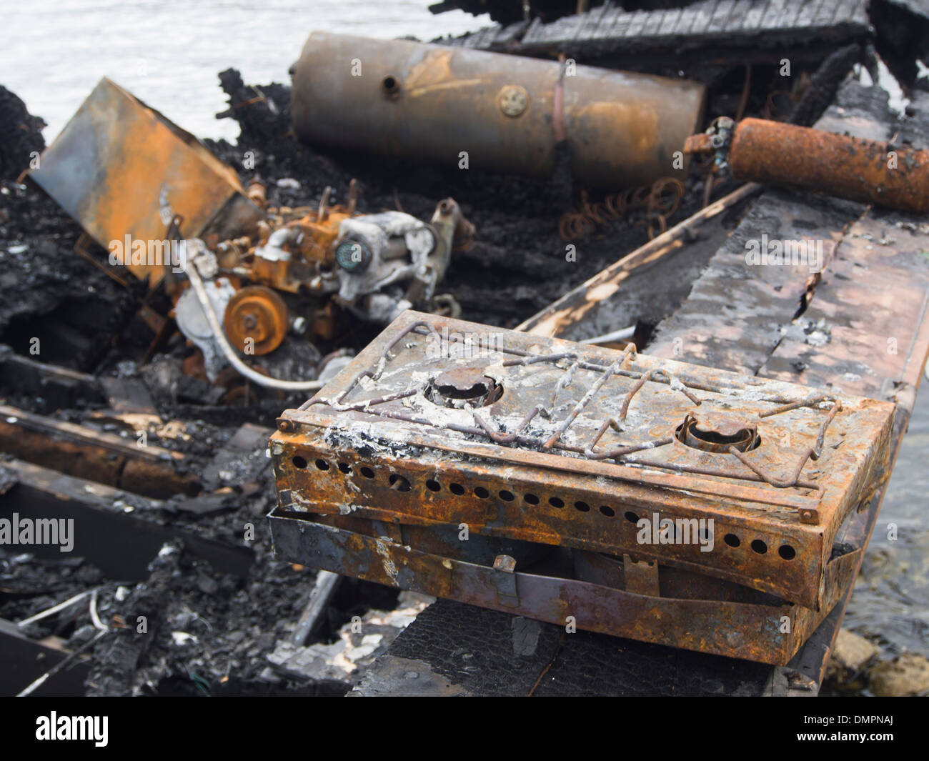 Remnants of a wooden pleasure boat after an intense fire charred wood ...