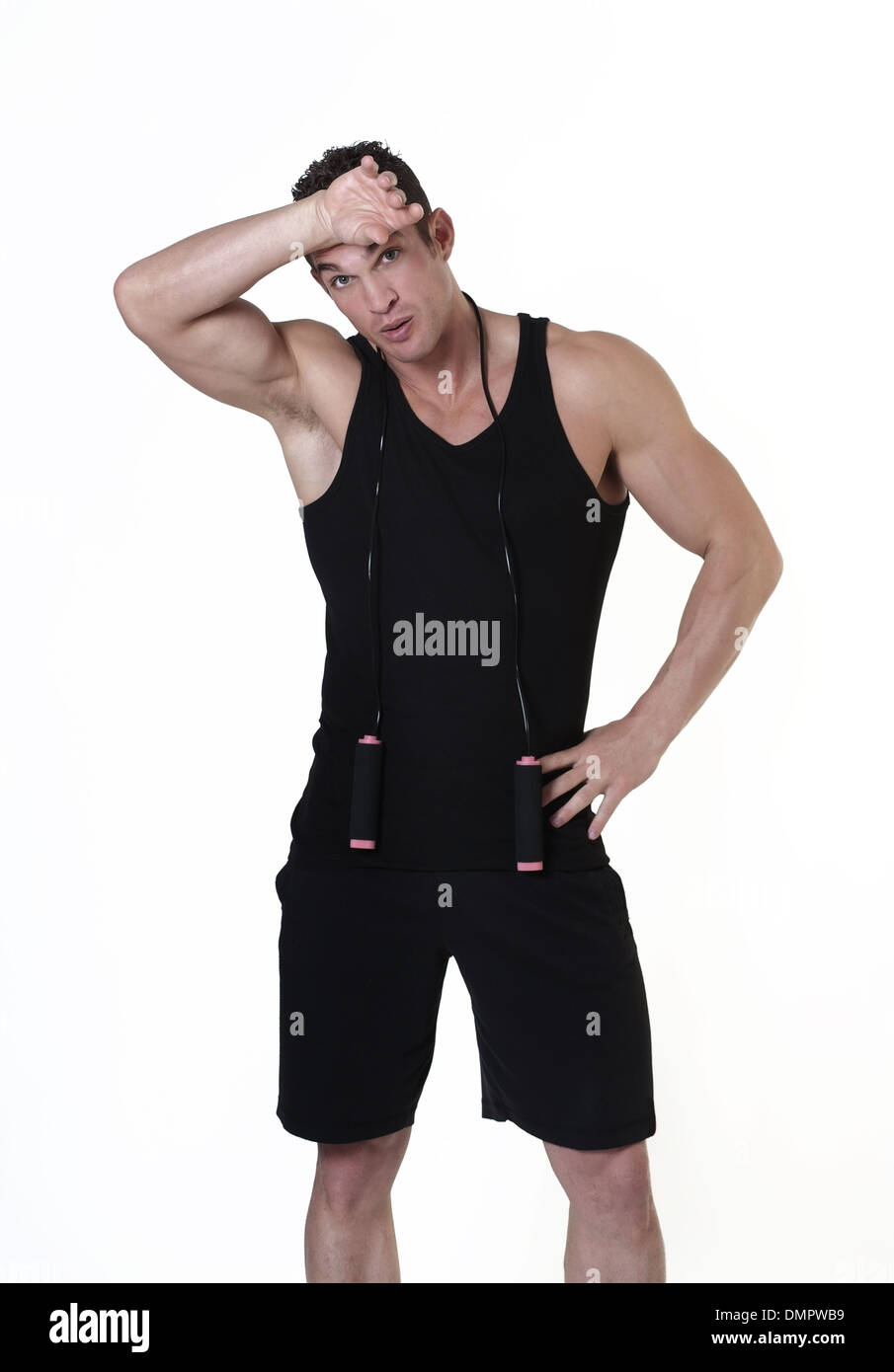 male bodybuilder with a skipping rope around his neck after a good work ...