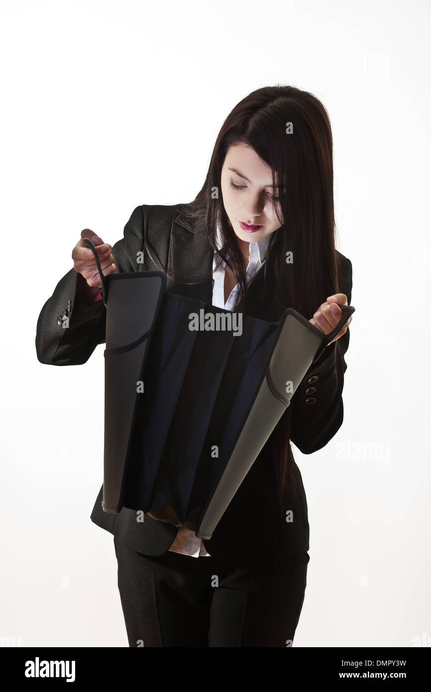 woman looking inside a case with a light source coming from the bag ...
