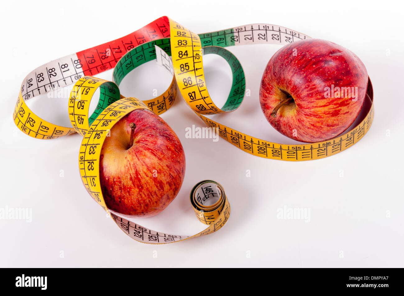 Tape measure and red apple isolated on white background Stock Photo - Alamy