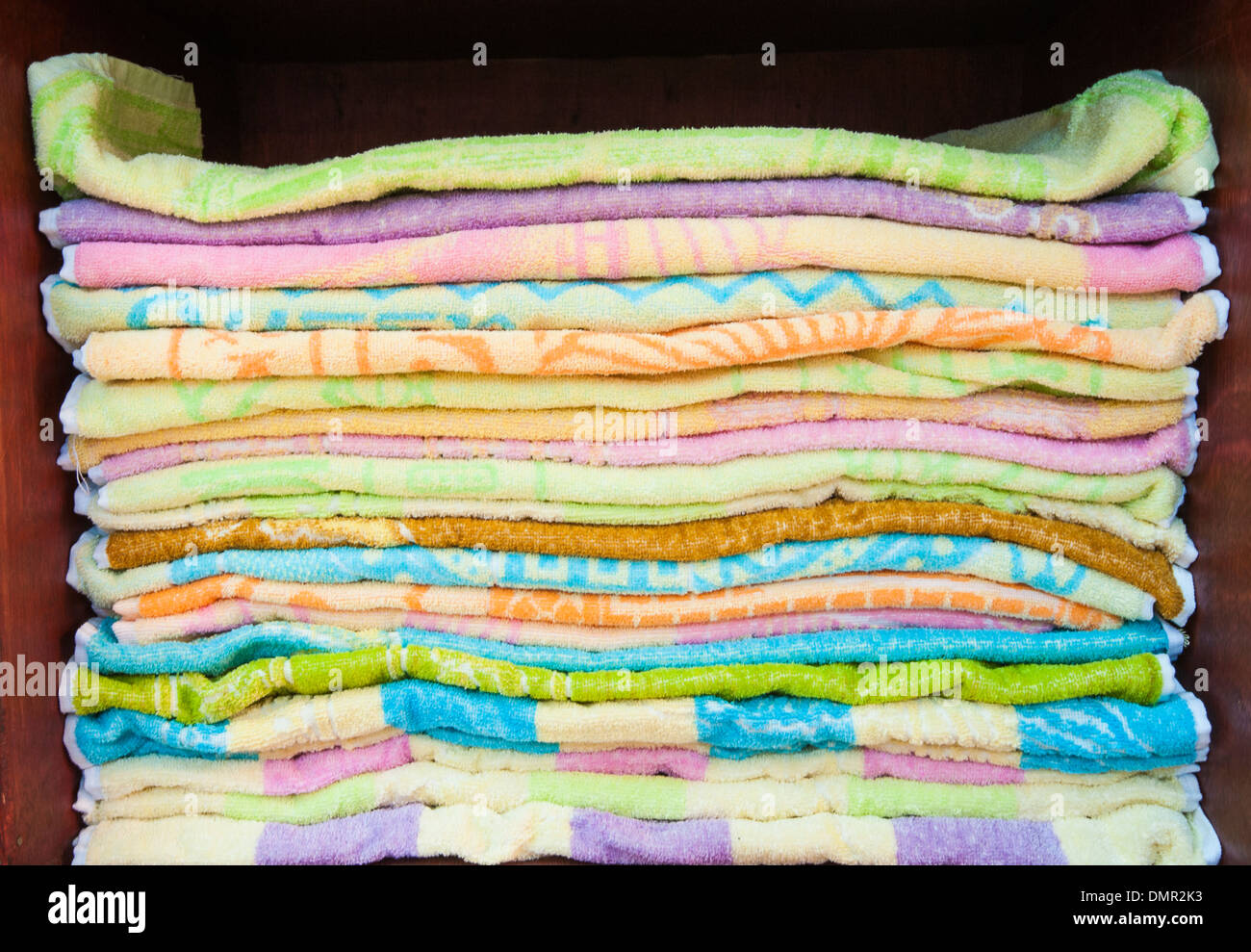 Stack of colorful towels in a cupboard in shop Stock Photo - Alamy