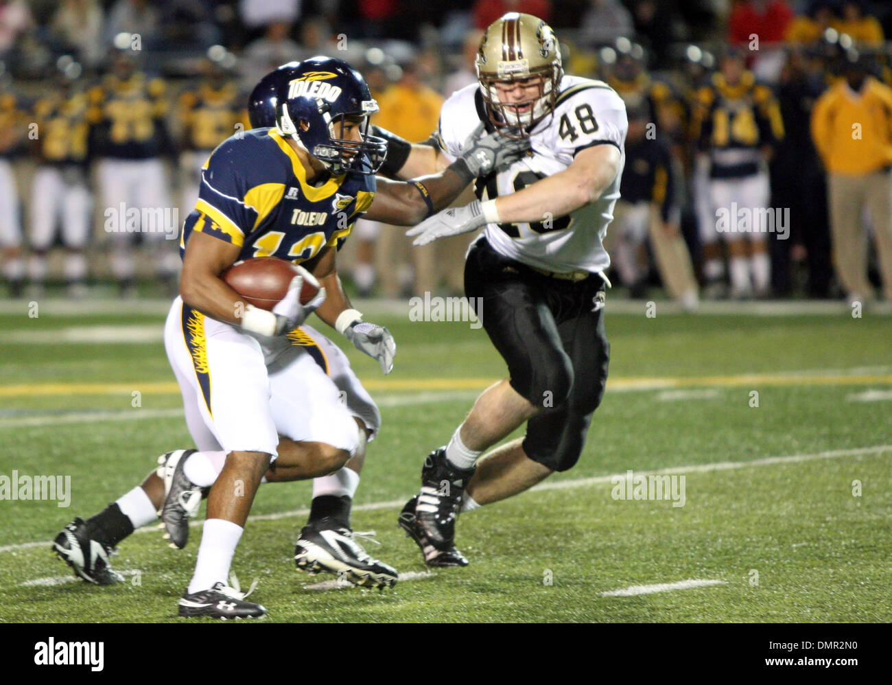 Toledo wide receiver Eric Page (12) and Western Michigan defensive end ...