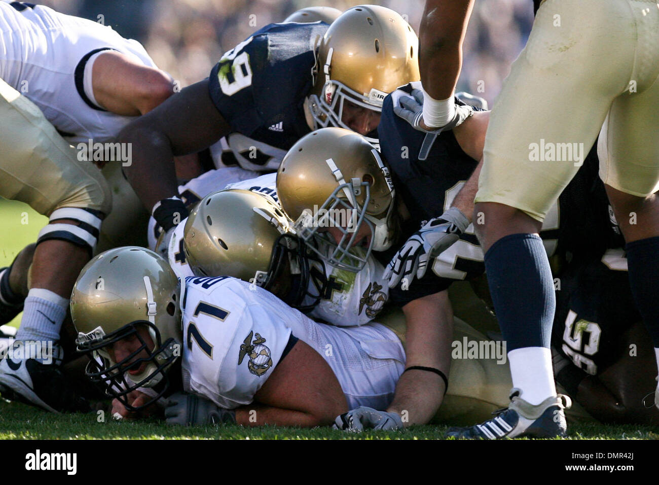 Navy quarterback Ricky Dobbs (4) is buried under a pile of Notre Dame ...