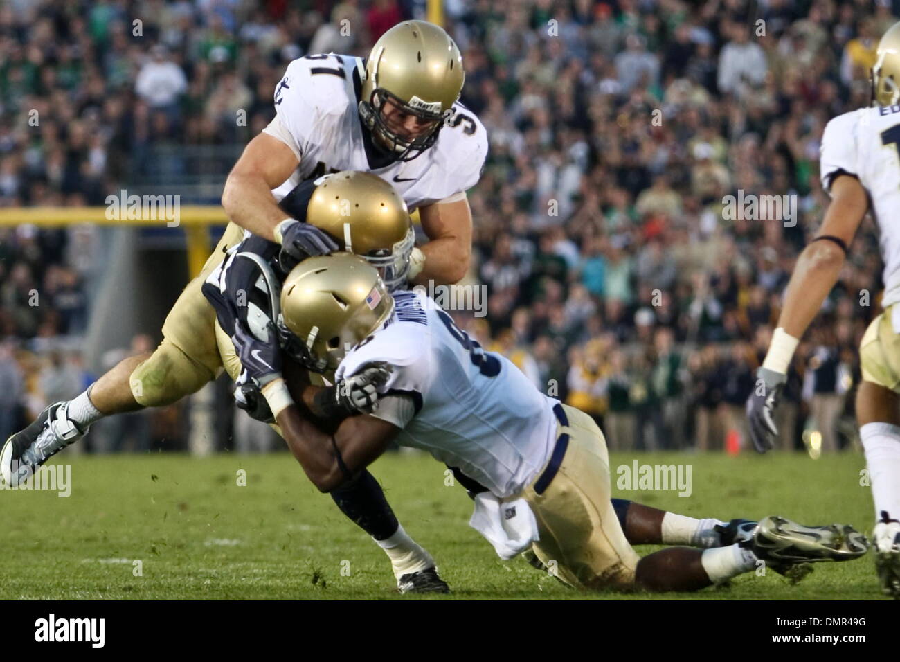 Navy linebacker Ross Pospisil (51) and safety Wyatt Middleton (8) take ...
