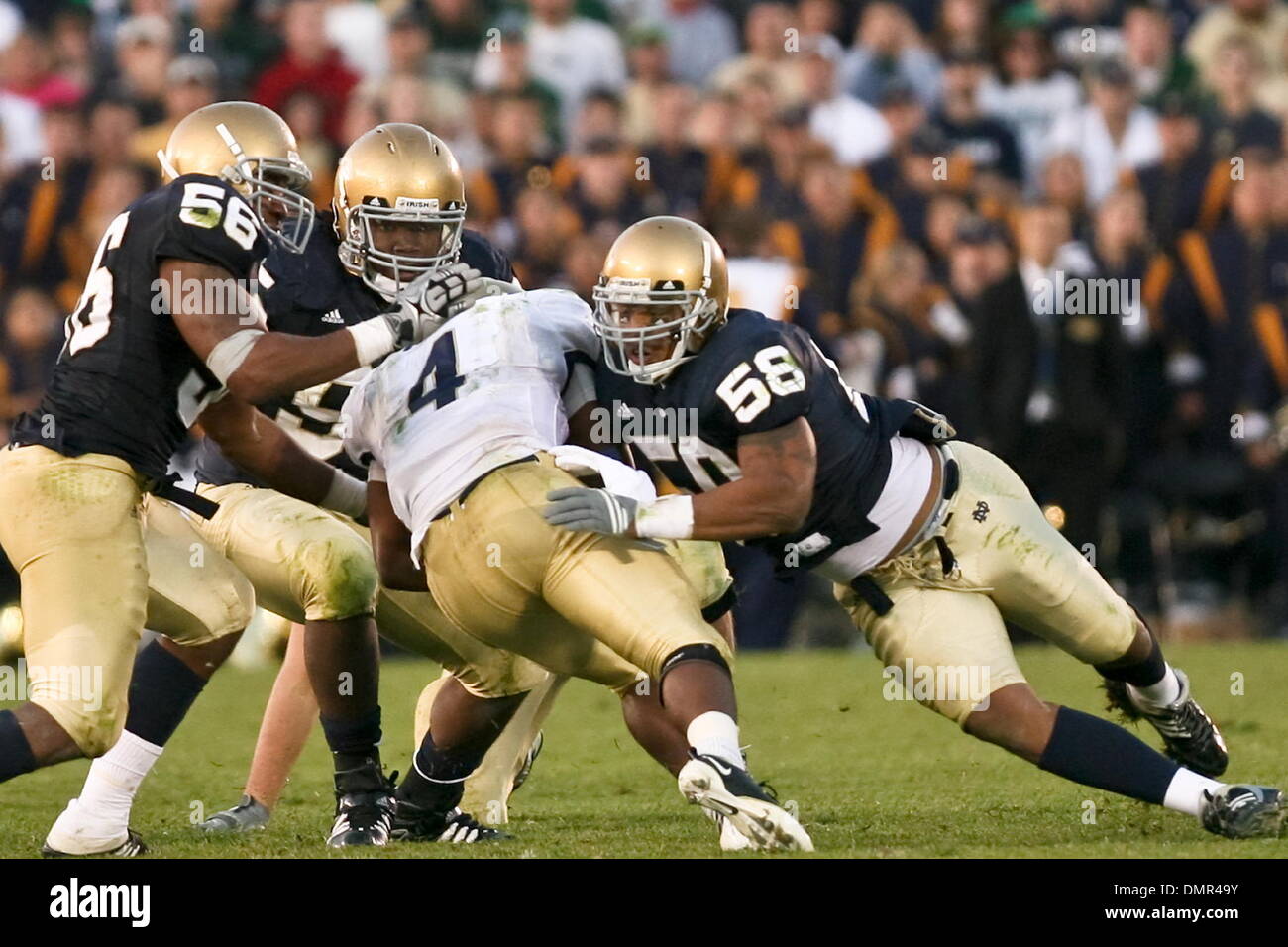 Navy quarterback Ricky Dobbs (4) is tackled by Notre Dame linebacker ...