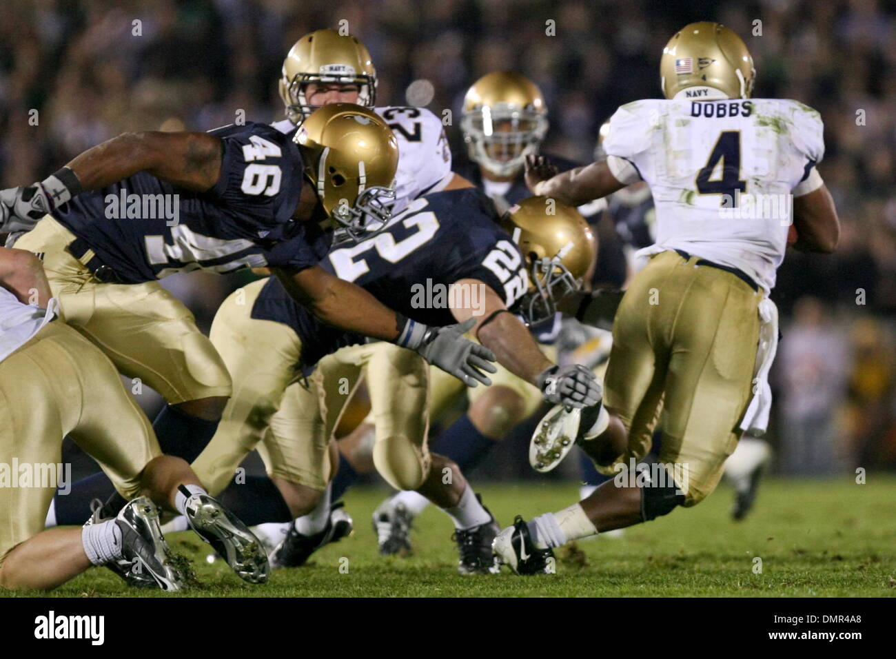 Navy quarterback Ricky Dobbs (4) tries to avoid being tacked by the ...