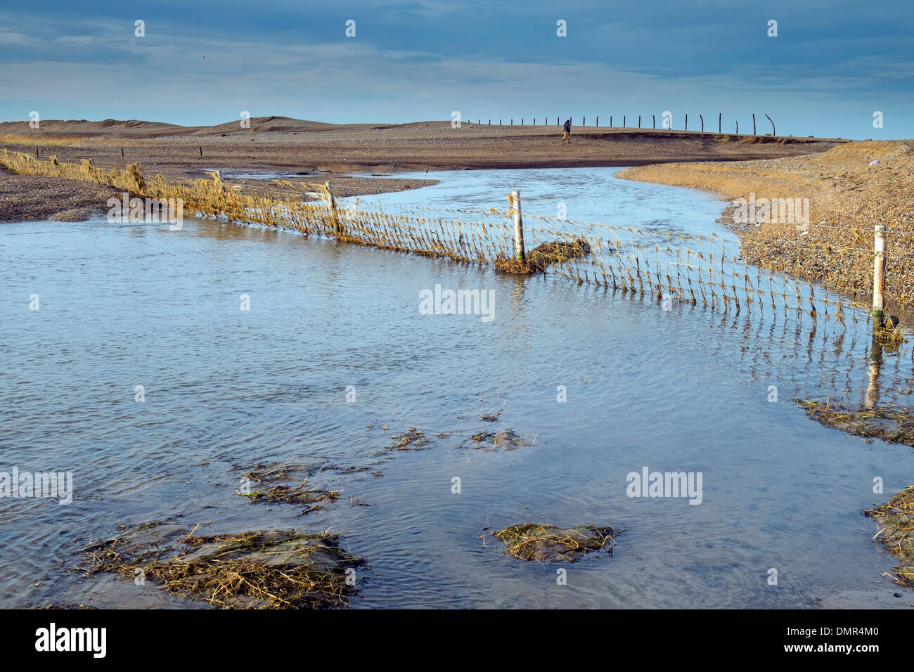 Grazing marsh and stock fencing engulfed by flood waters and shifting ...