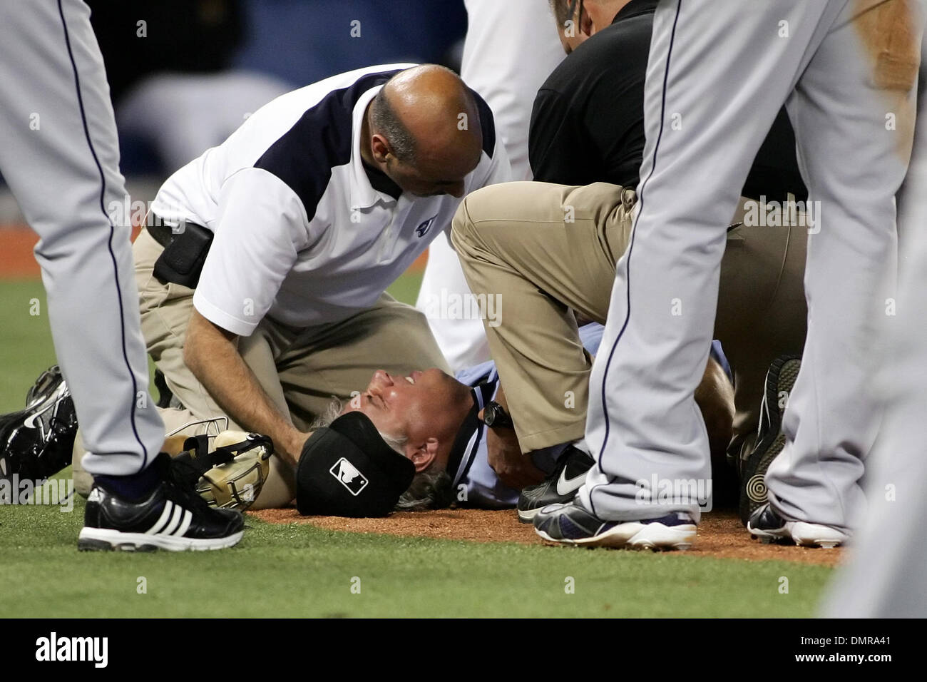 Home-plate umpire Tom Hallion after being hit in the chest by a ball at ...