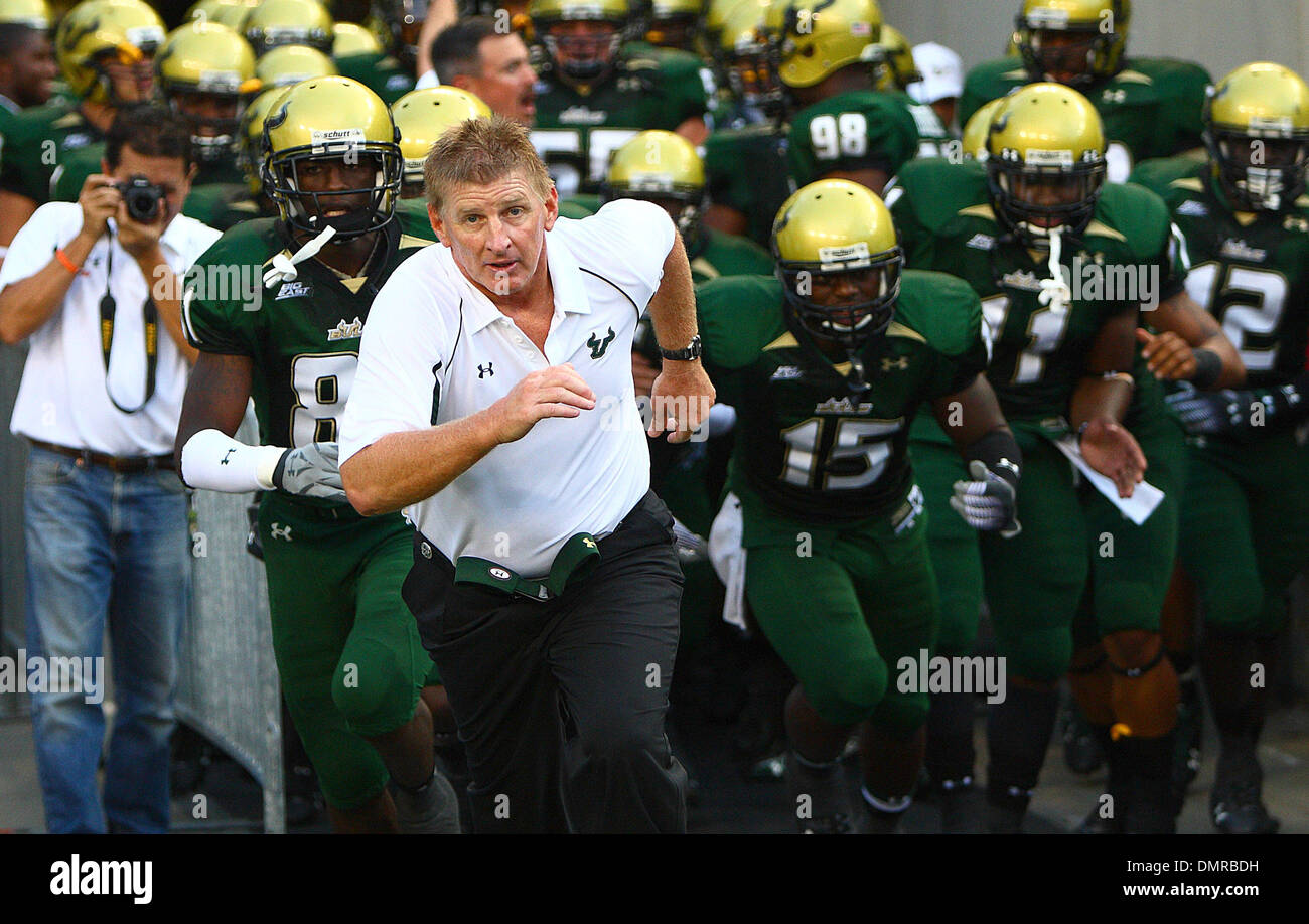 South Florida head coach Jim Leavitt rushes the field with his players ...