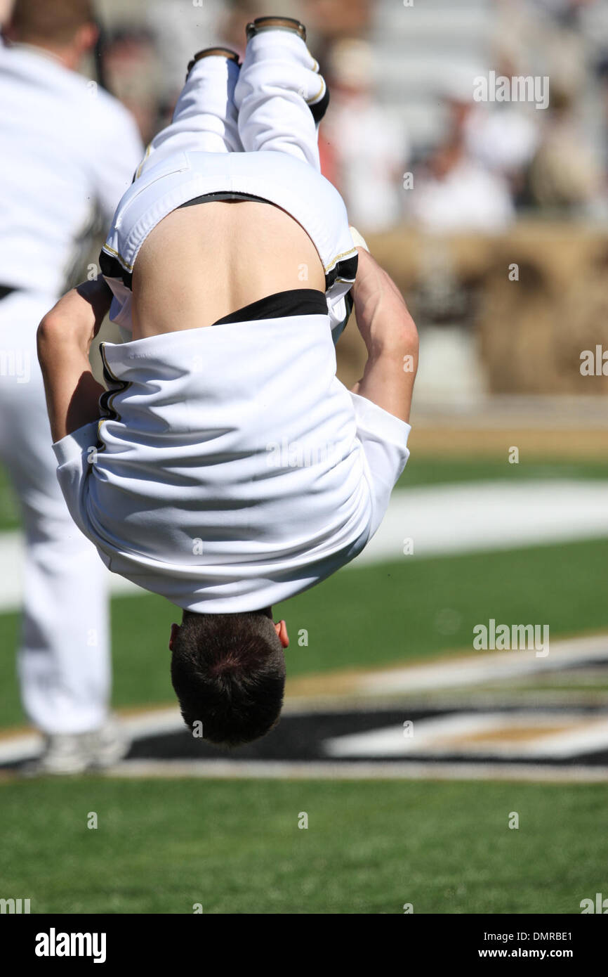 Army cheerleader does a somersault during game action in the second ...