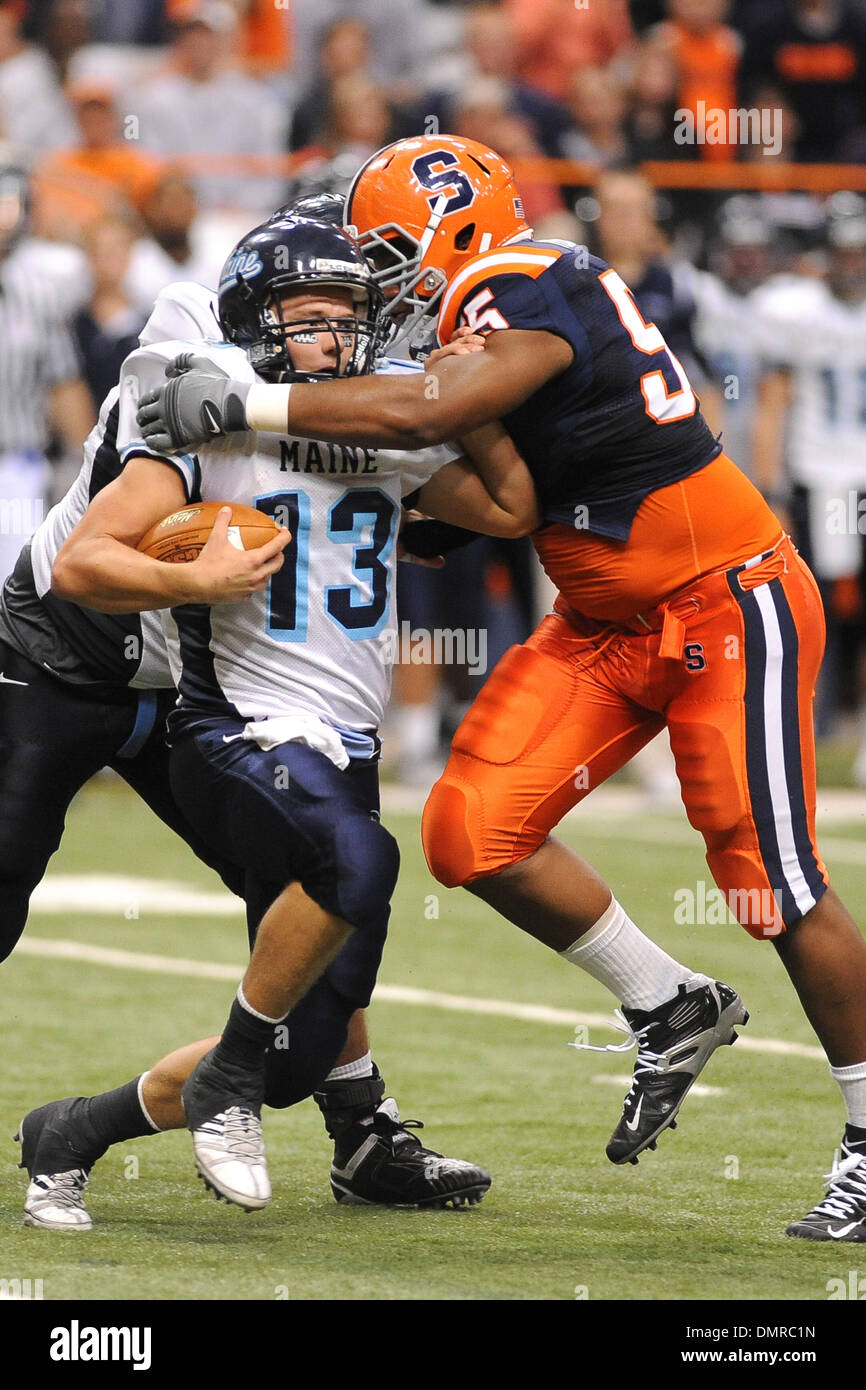 Maine quarterback Warren Smith (13) is sacked by Syracuse defensive ...