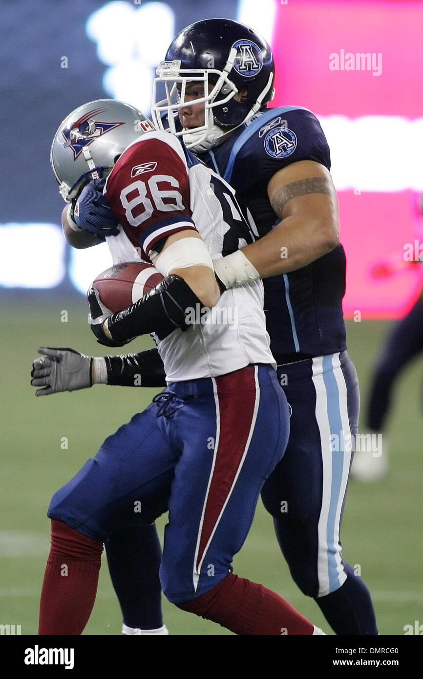 Montreal Alouettes Ben Cahoon is tackled by Toronto Argonauts line ...