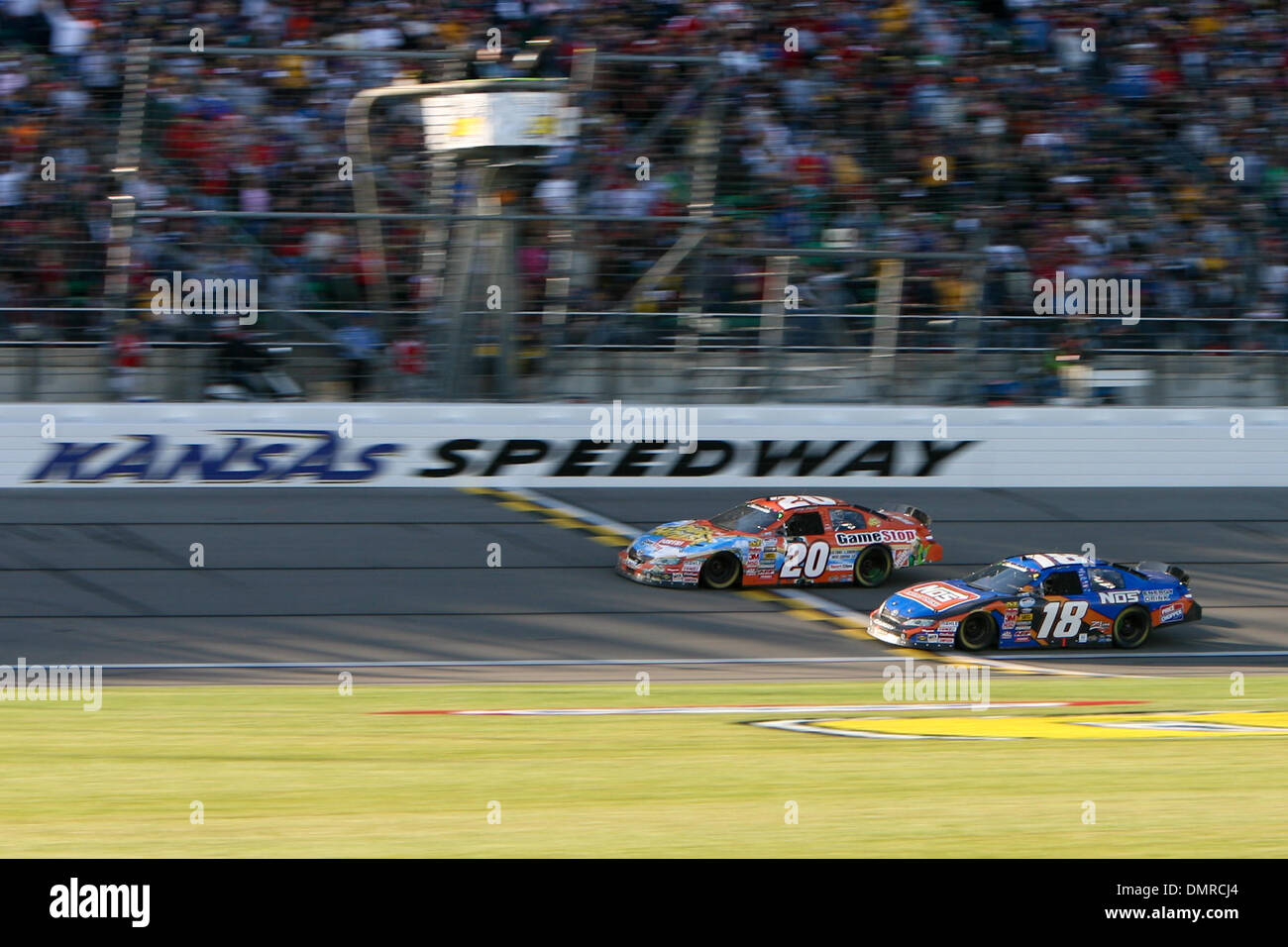 03 October 2009: Joey Logano #20 passes Kyle Busch #18 with three laps ...
