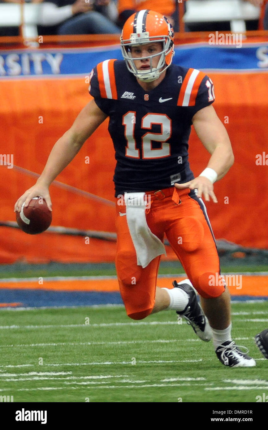 Syracuse quarterback Ryan Nassib (12) scrambles up field in the third ...
