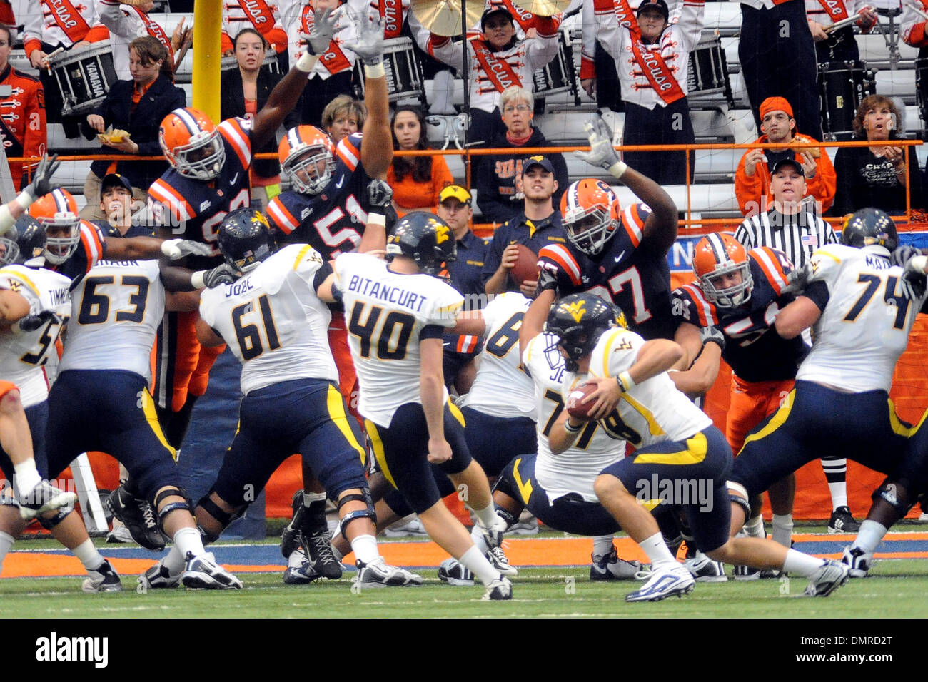 West Virginia holder Jeremy Kash (right) takes the ball on a fake extra ...
