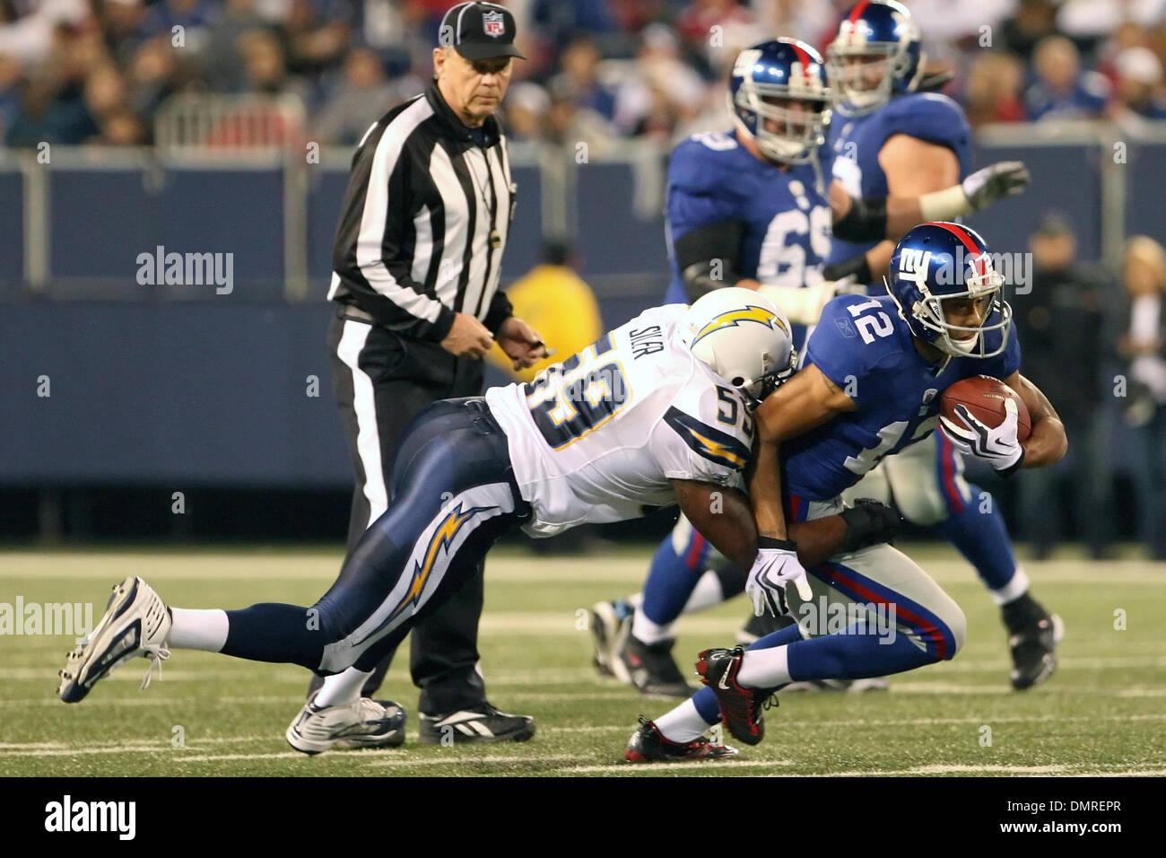 New York Giants #12 wide reciever Steve Smith pulled down by San Diego ...