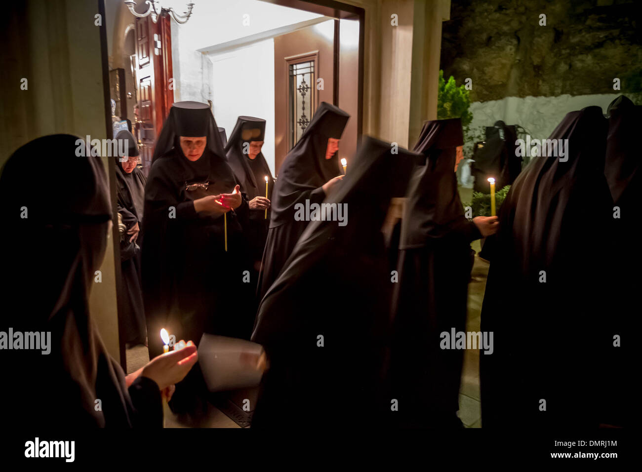 Orthodox nuns with prayer candles attending a night liturgy at ...