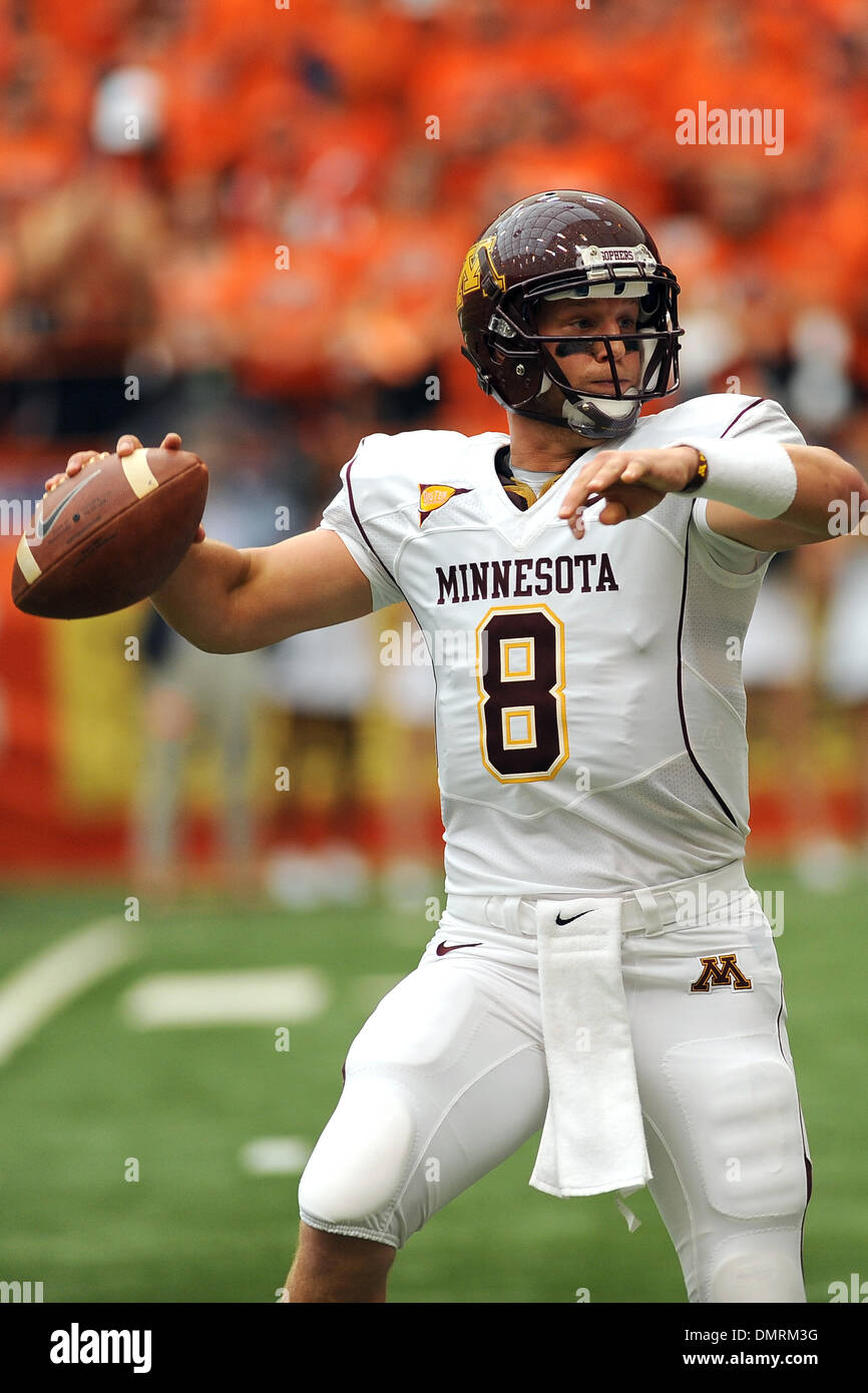 Minnesota Golden Gopher quarterback Adam Weber looks to fire the ball ...