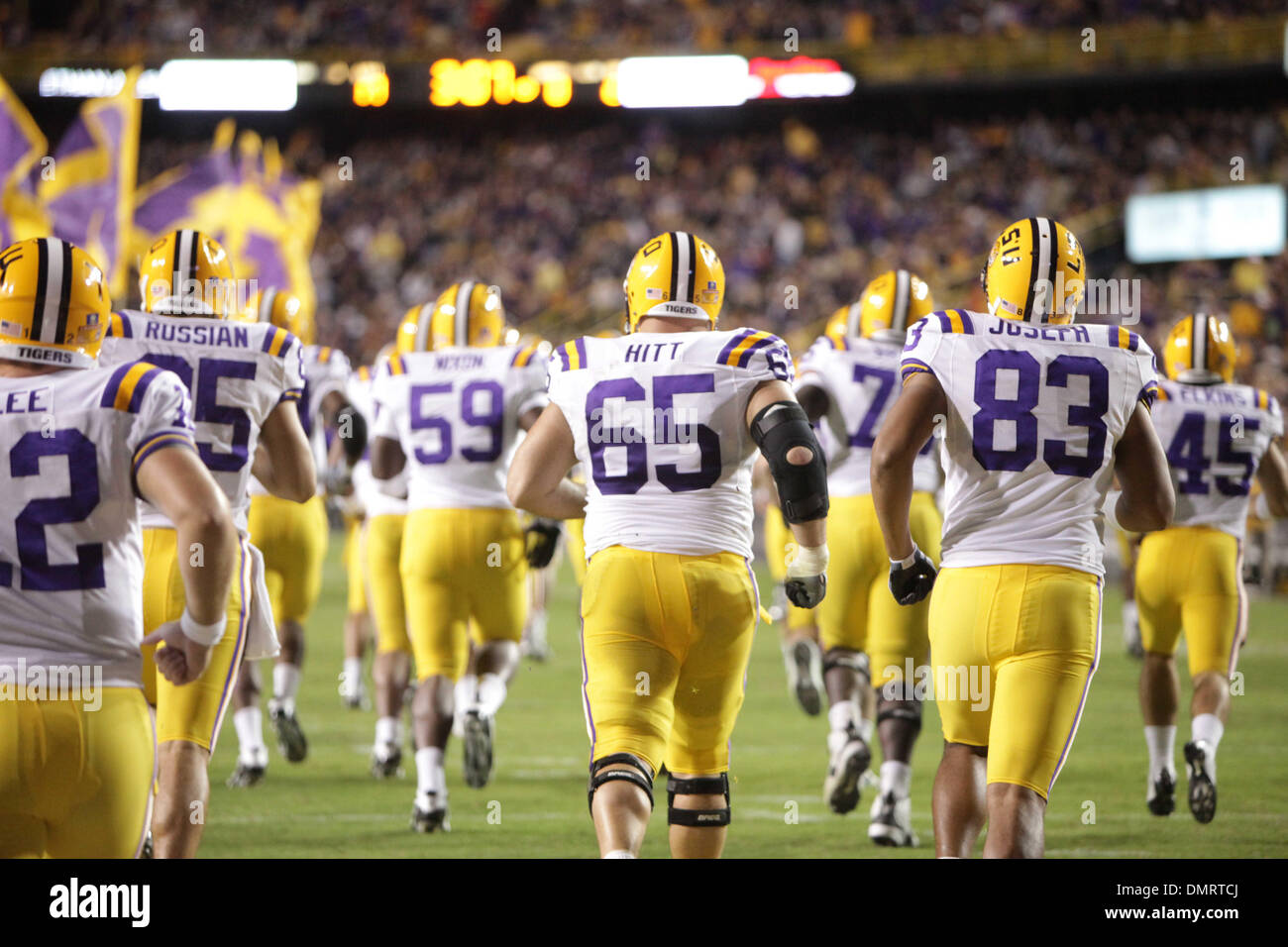Offensive lineman Lyle Hitt (65) and the LSU Tigers take the field ...