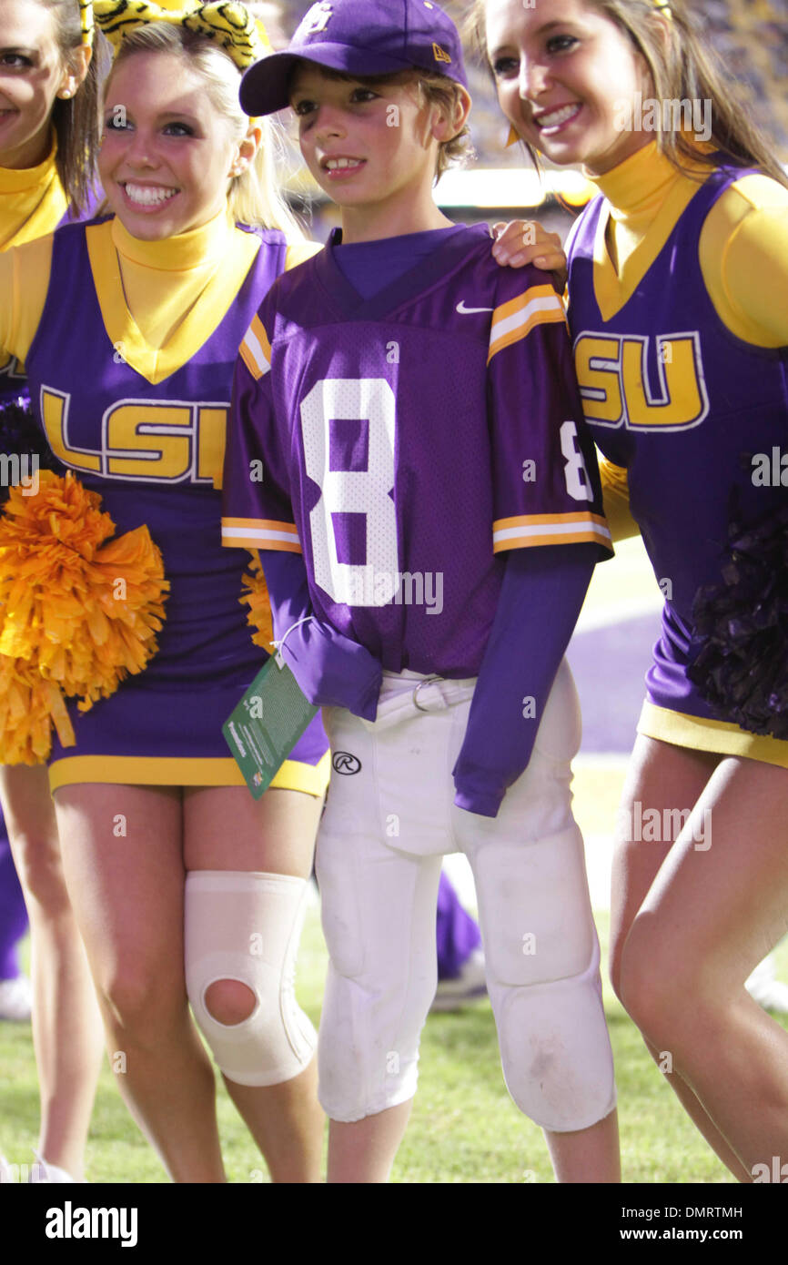 A young LSU fan poses for a picture with the cheerleaders during the ...