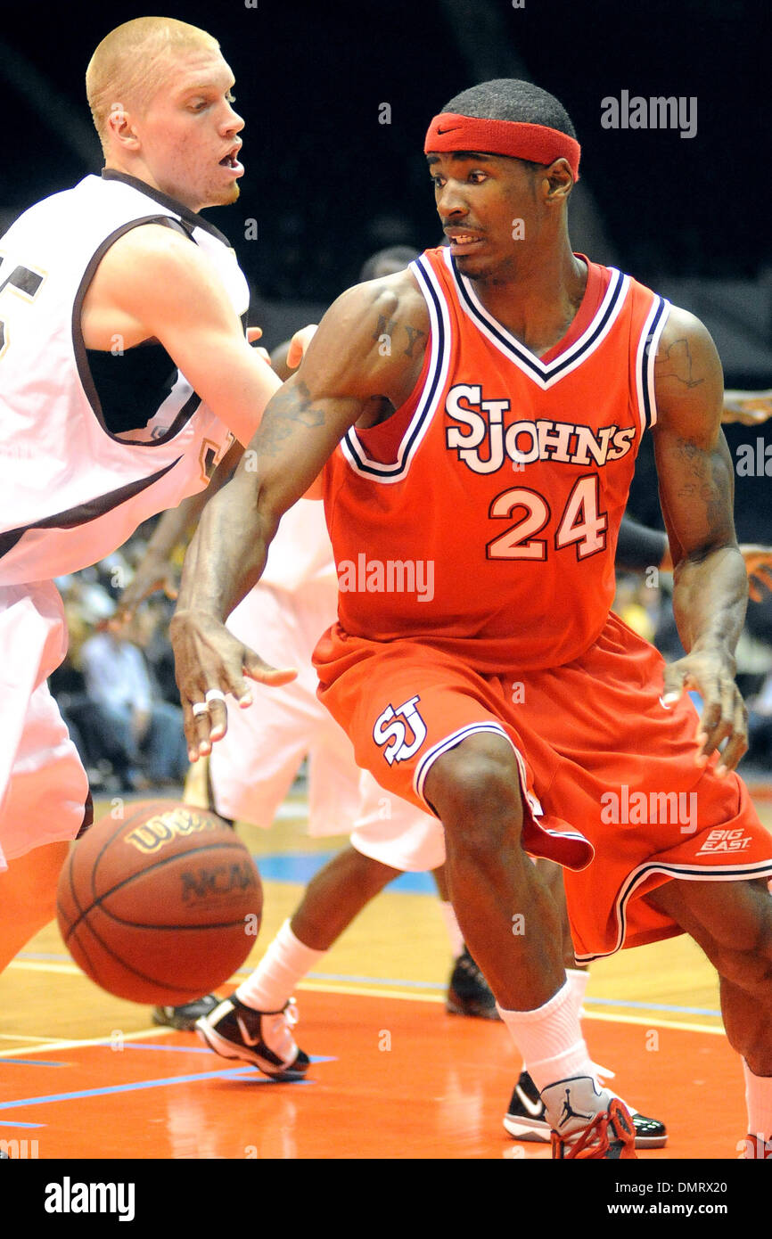 St. John's Justin Burrell (24) tries to spin to the hoop on St ...