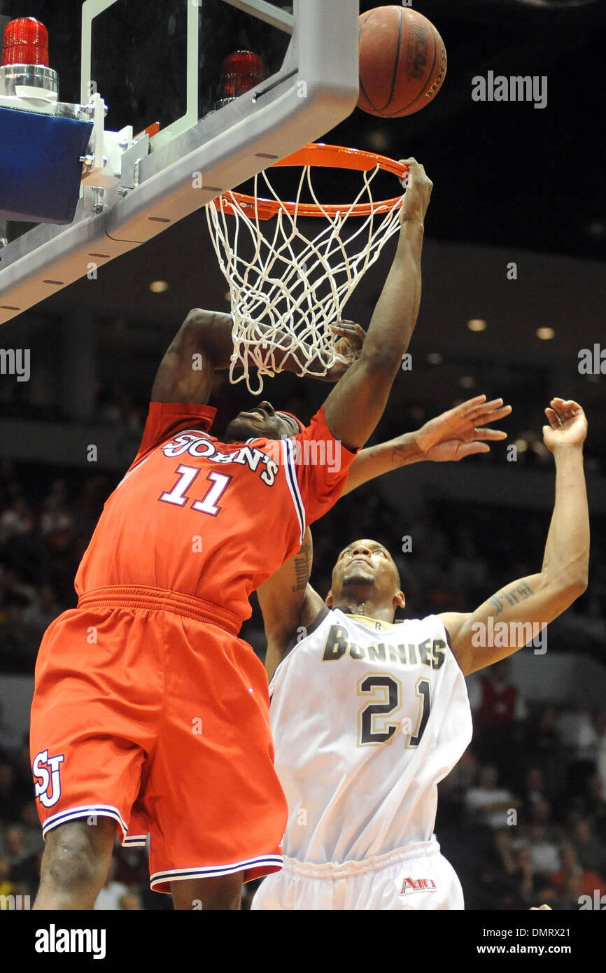 St. John's Omari Lawrence (11) can not finish the dunk after being ...